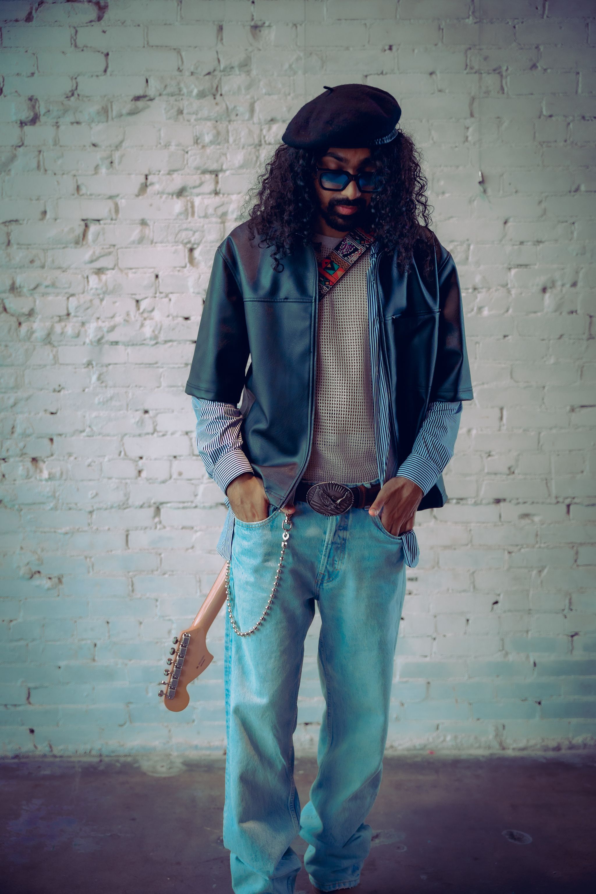A man with long hair and beard standing in front of a brick wall · Free ...
