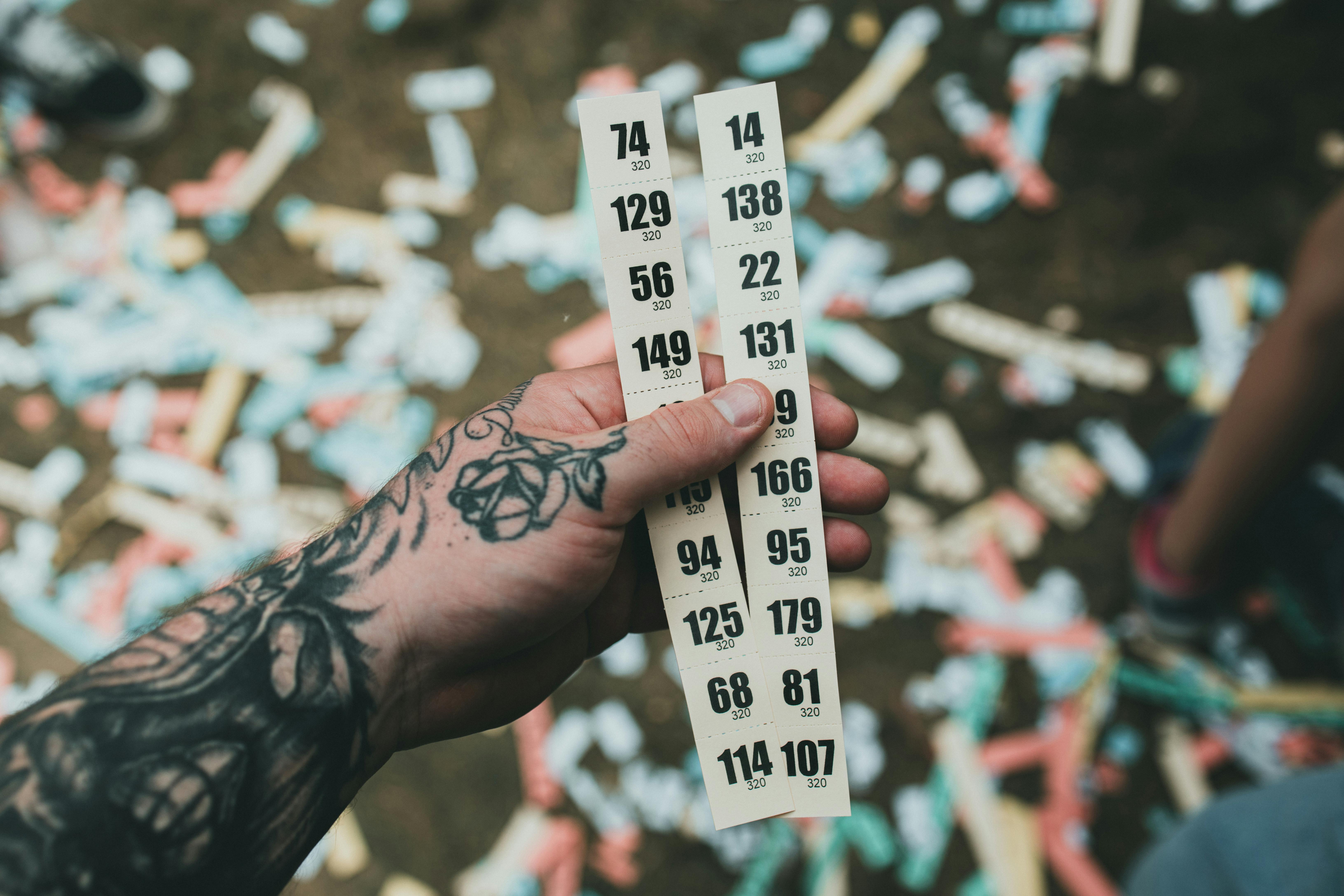 A person holding a ticket with numbers on it · Free Stock Photo
