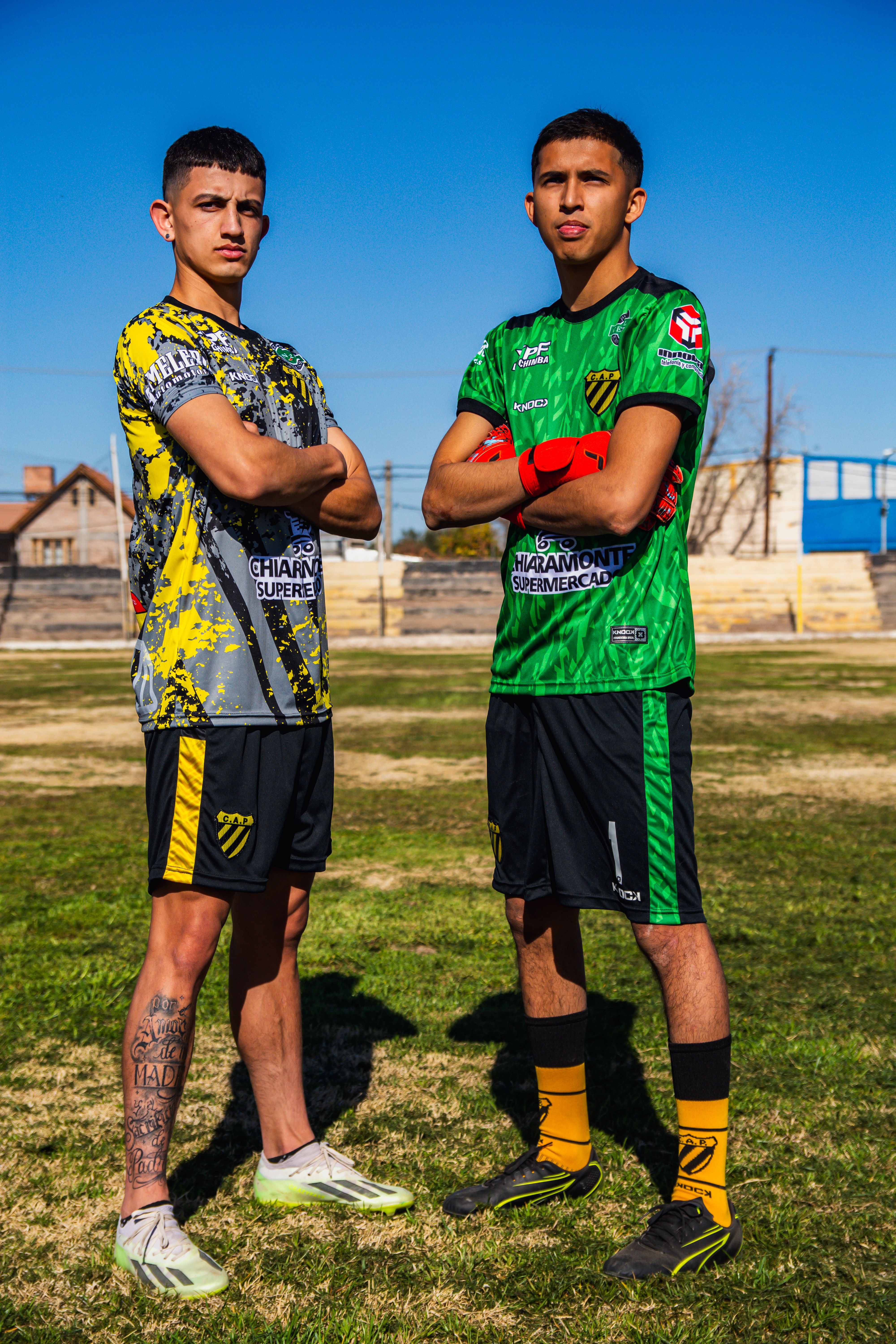Two soccer players standing next to each other in a field · Free Stock ...