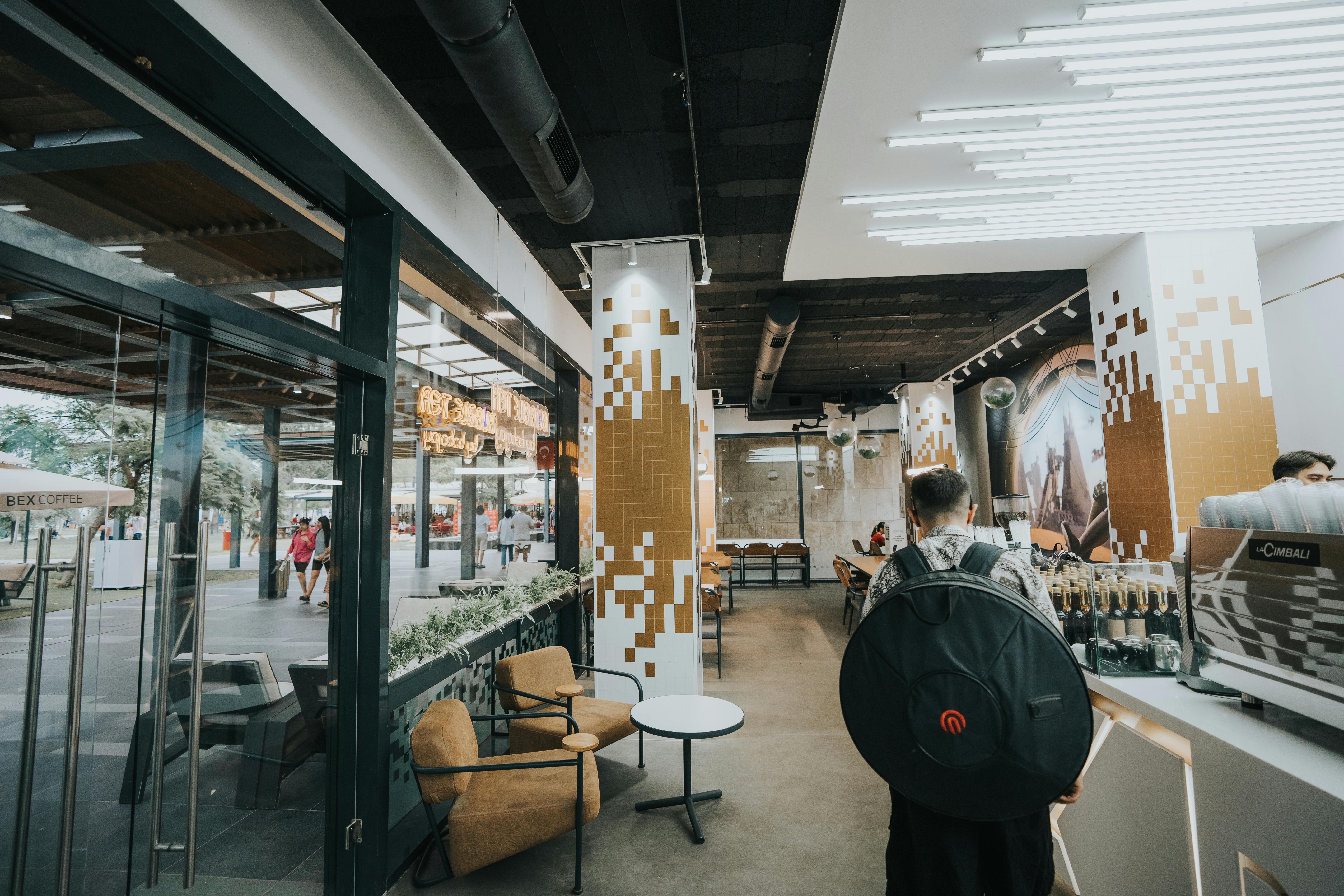 Group of diverse friends sitting in modern cafe · Free Stock Photo