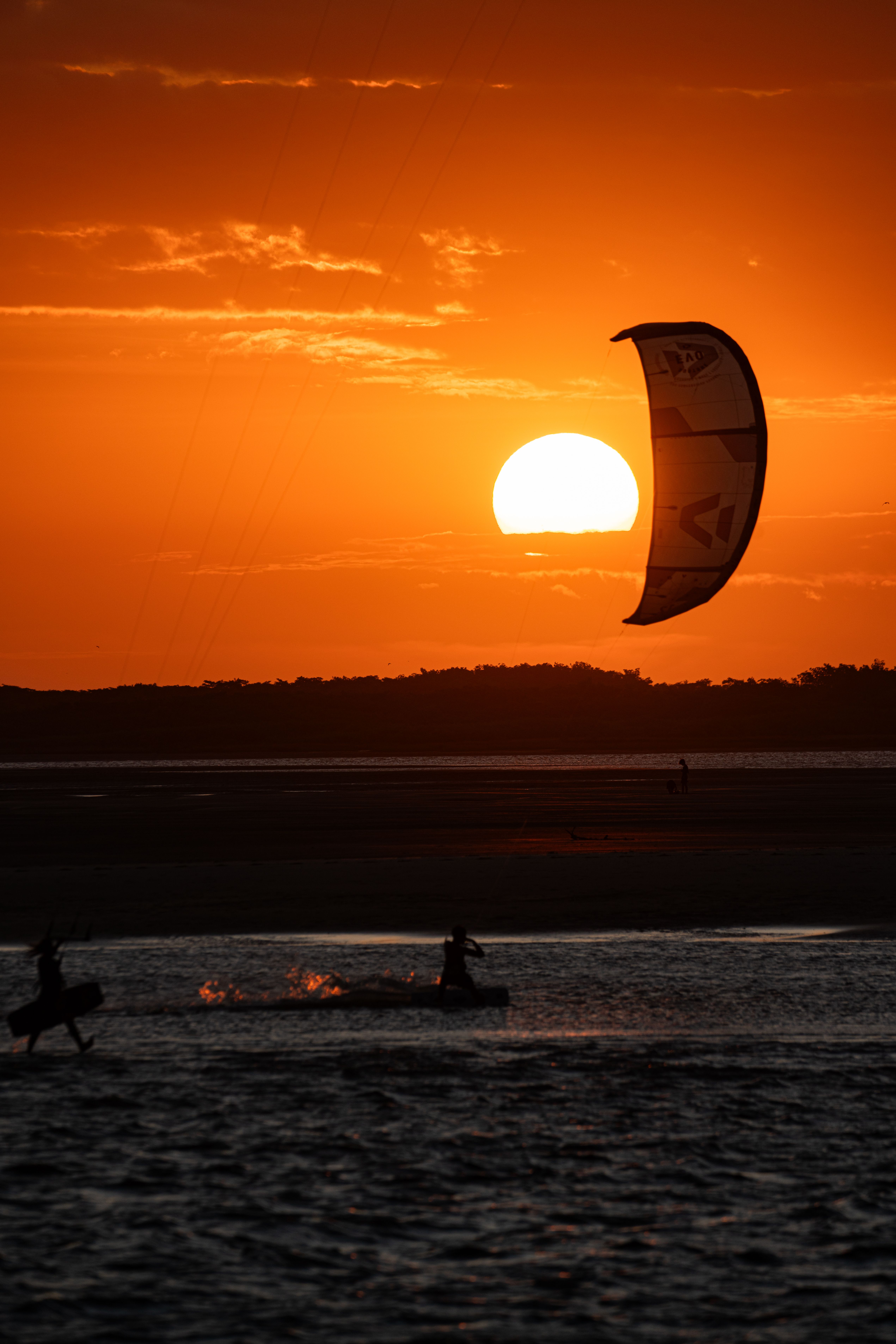 Person in Front of Man Flying Wearing Hat during Sunset · Free Stock Photo