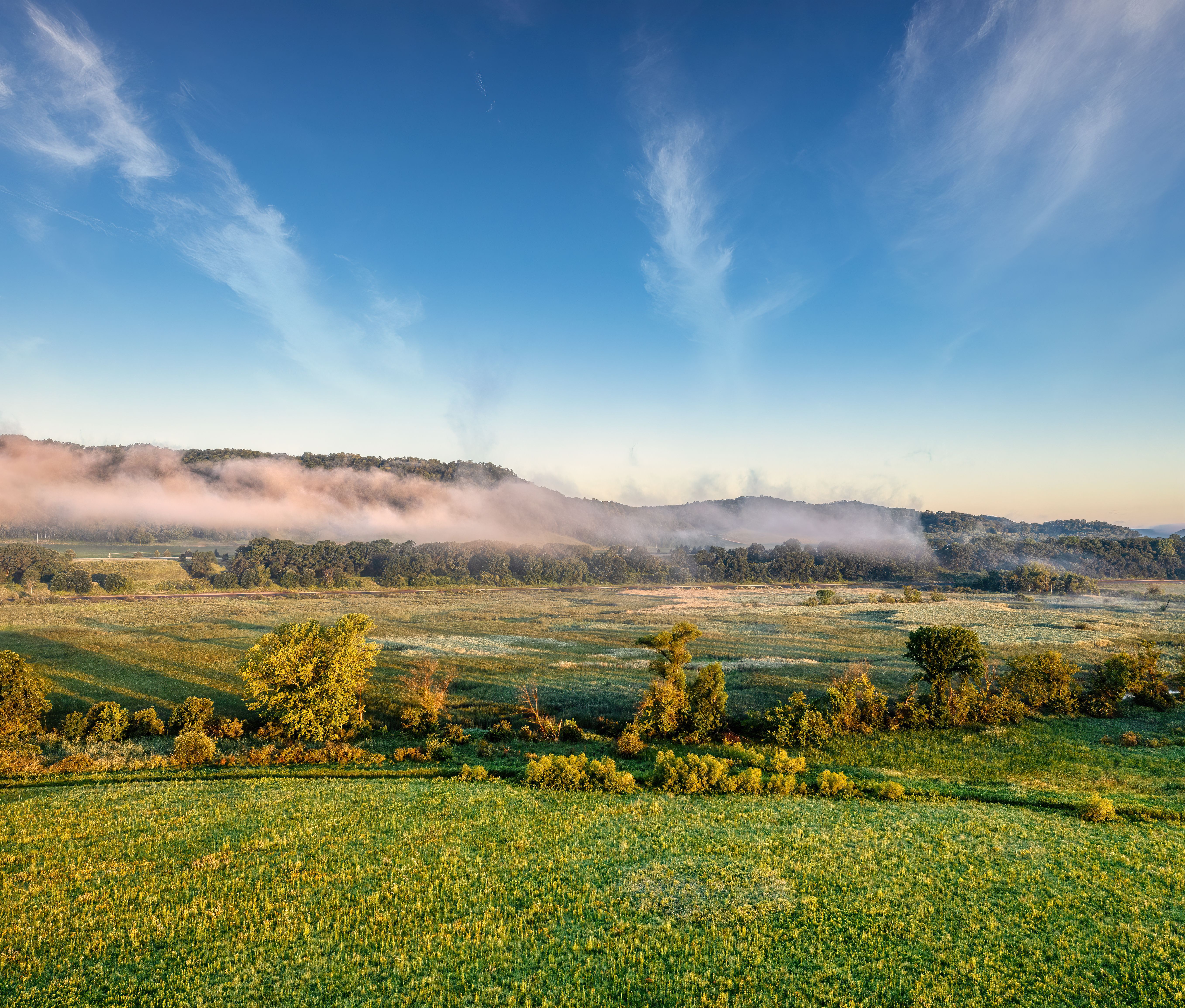 A field with mist and fog in the distance · Free Stock Photo