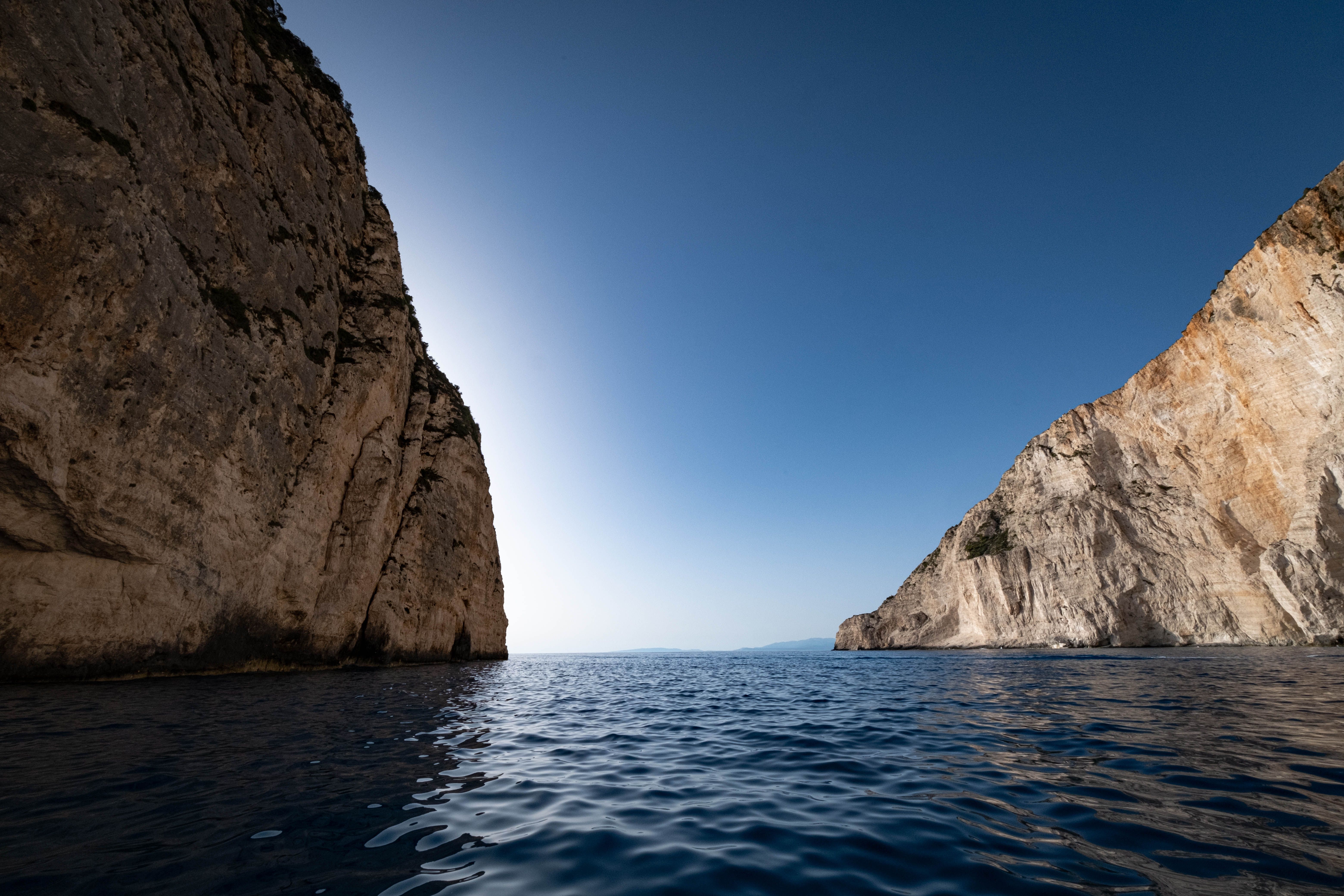 The blue water and cliffs of a rocky coast · Free Stock Photo