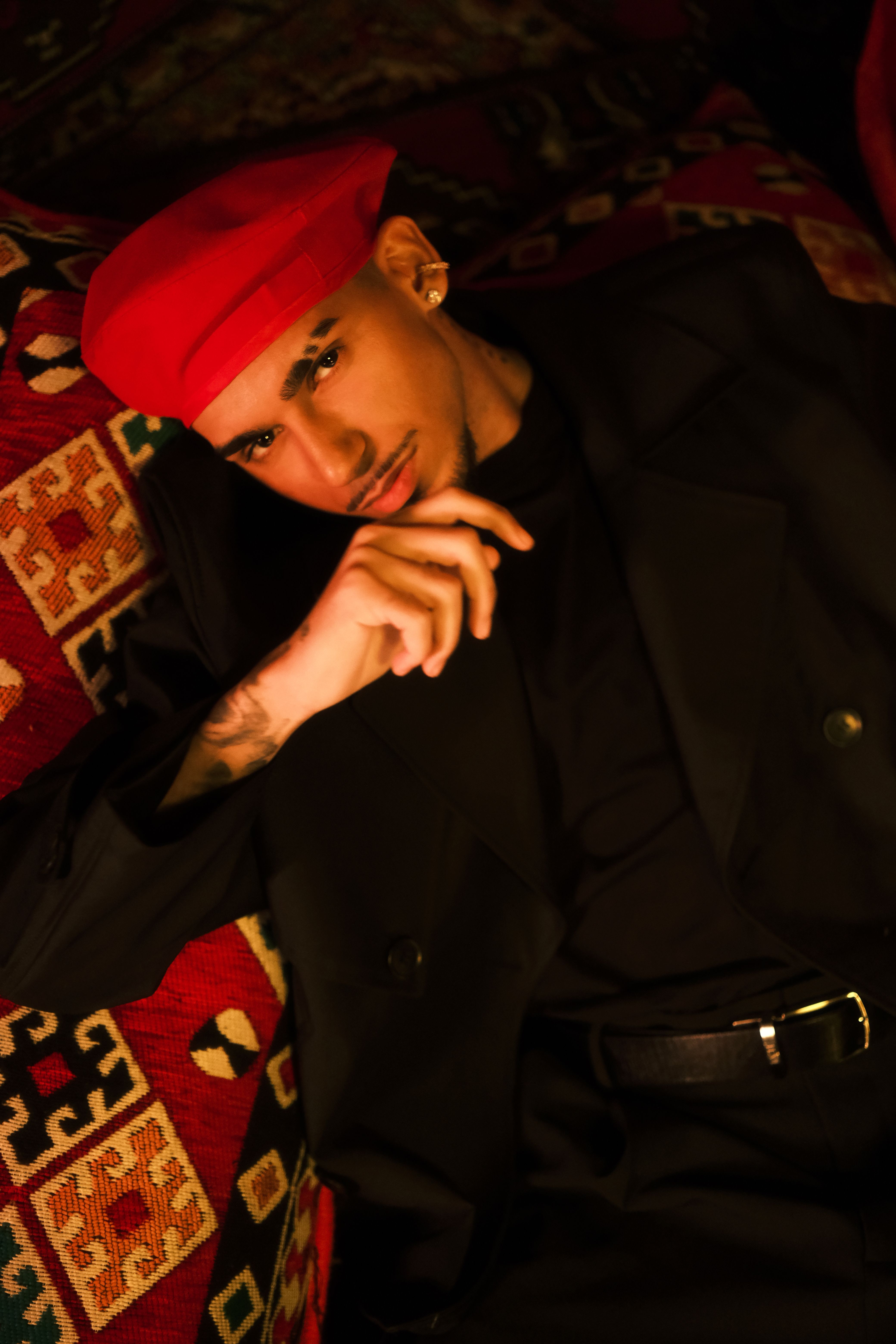 A man in a red beret sitting on a couch · Free Stock Photo