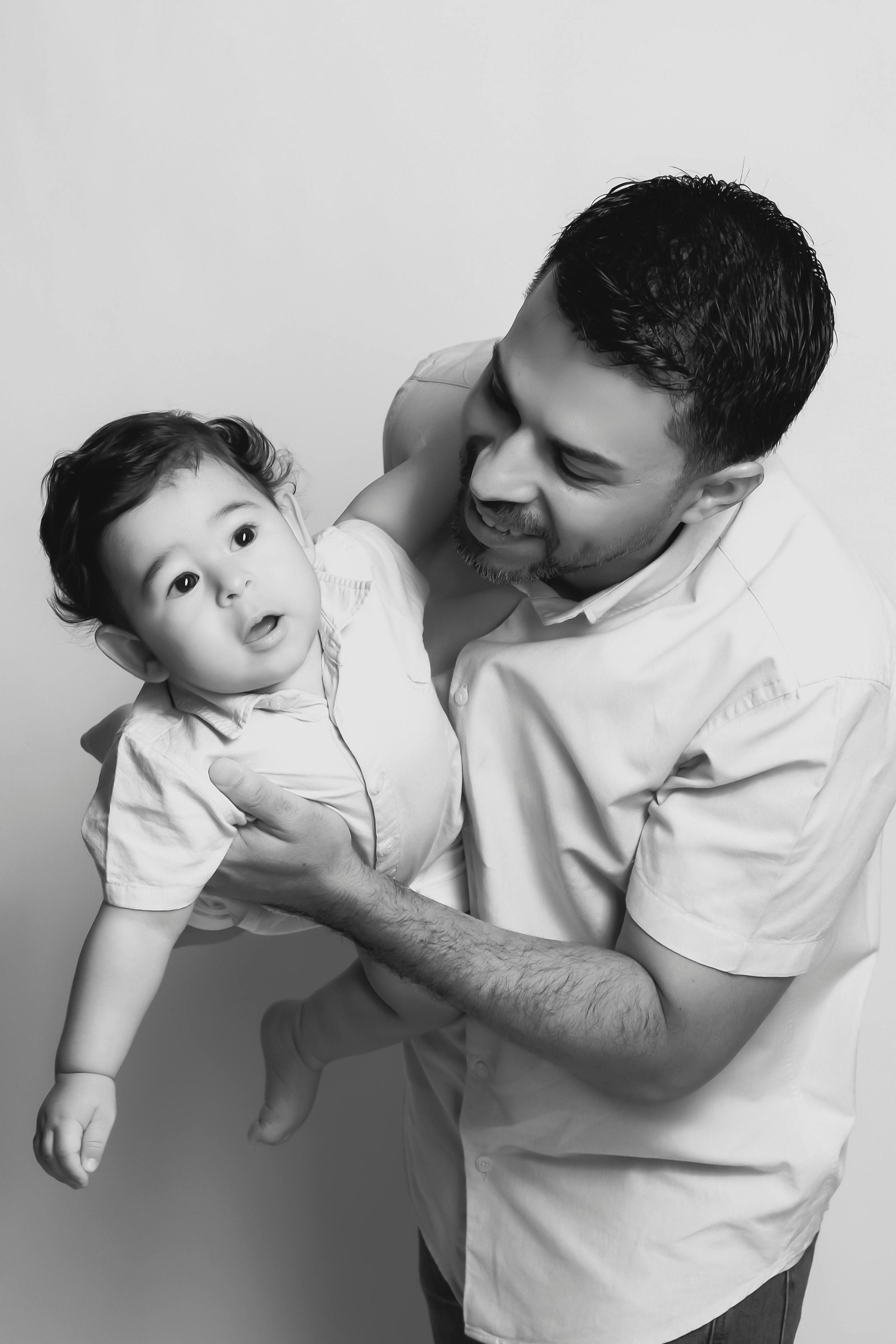 A Man Carrying a Baby on his Shoulder · Free Stock Photo