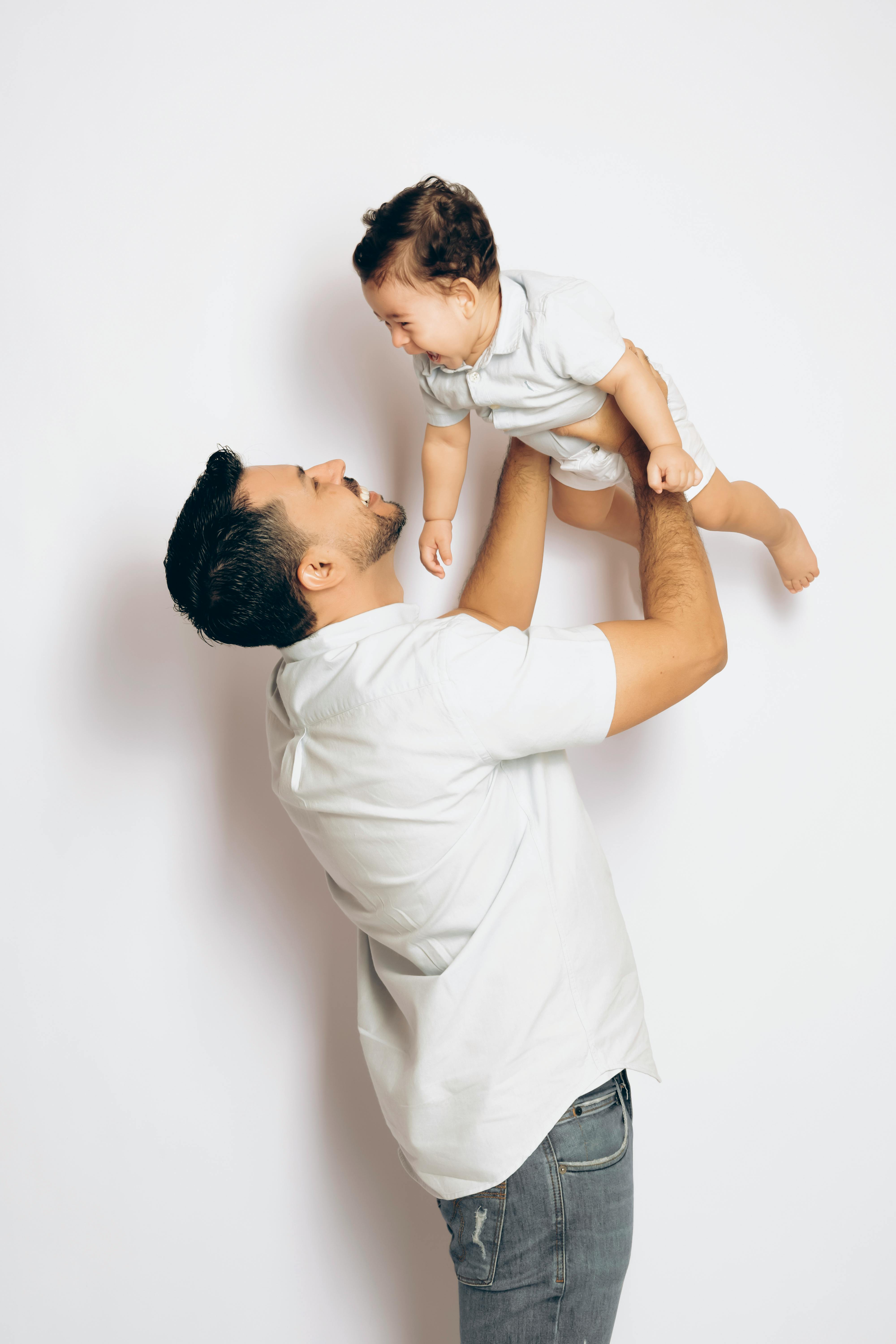 A Man Holding his Child · Free Stock Photo