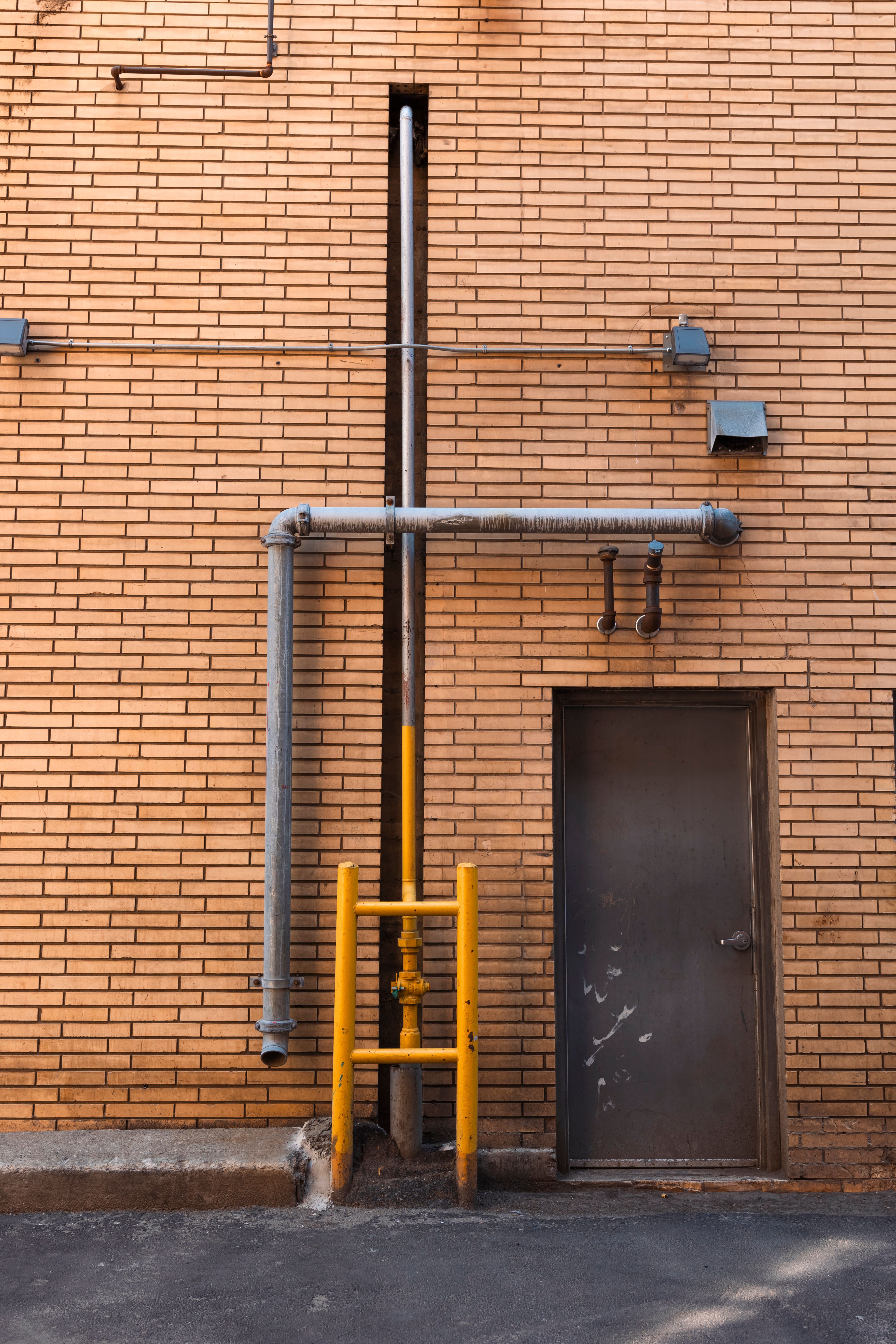 Drain Pipes and Gas Line Outside a Building · Free Stock Photo