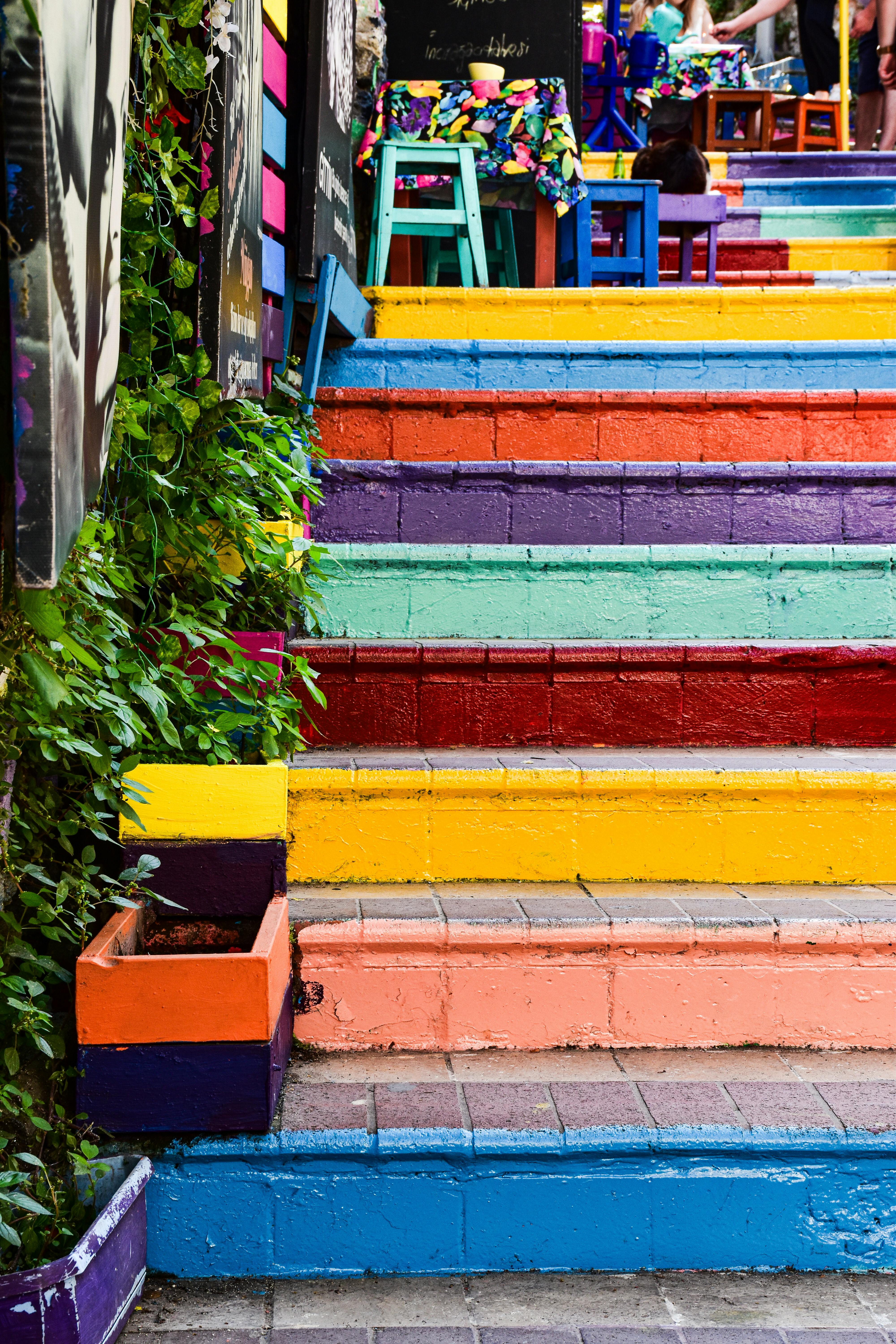 A colorful set of stairs with colorful chairs · Free Stock Photo