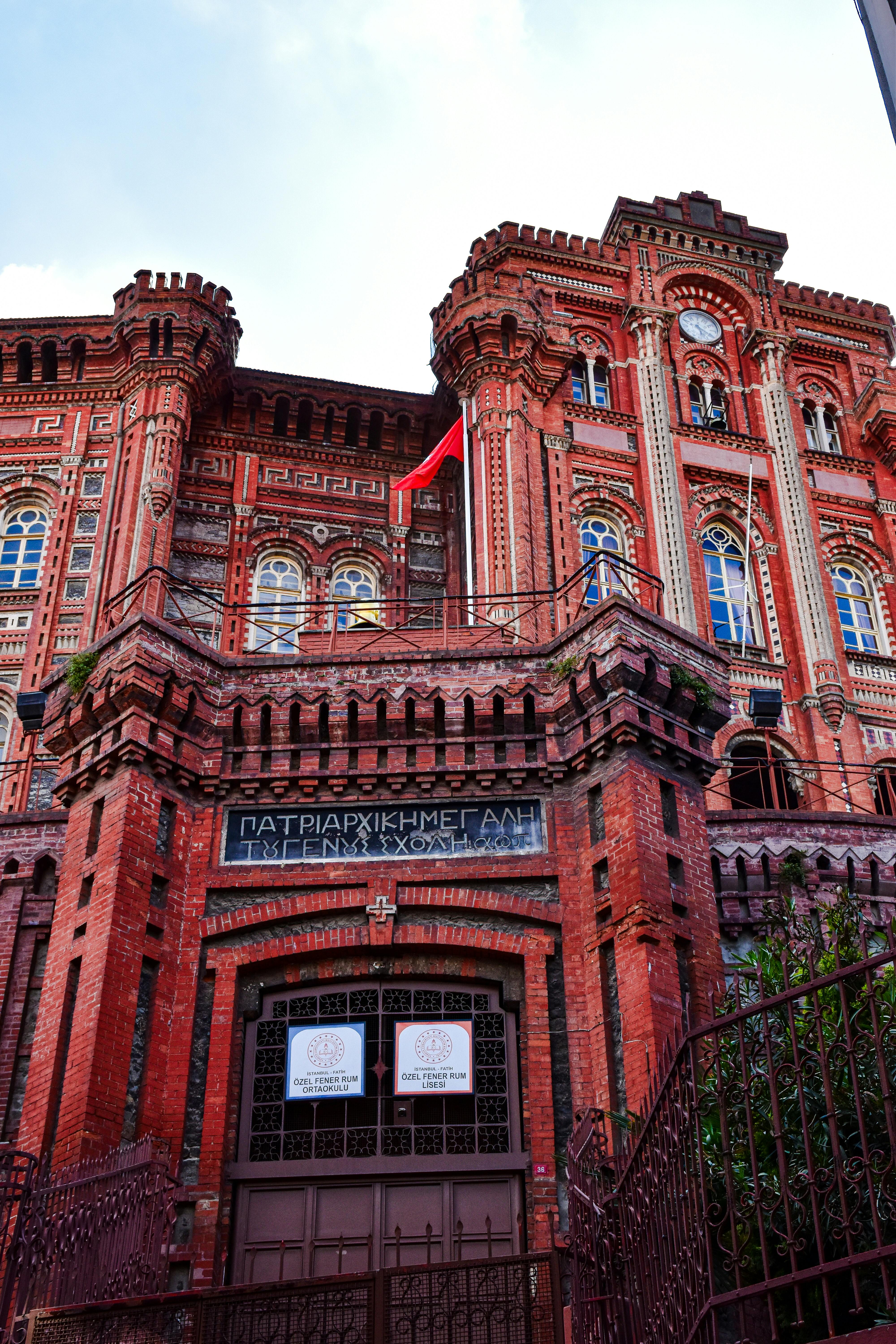 A red brick building with a clock tower · Free Stock Photo