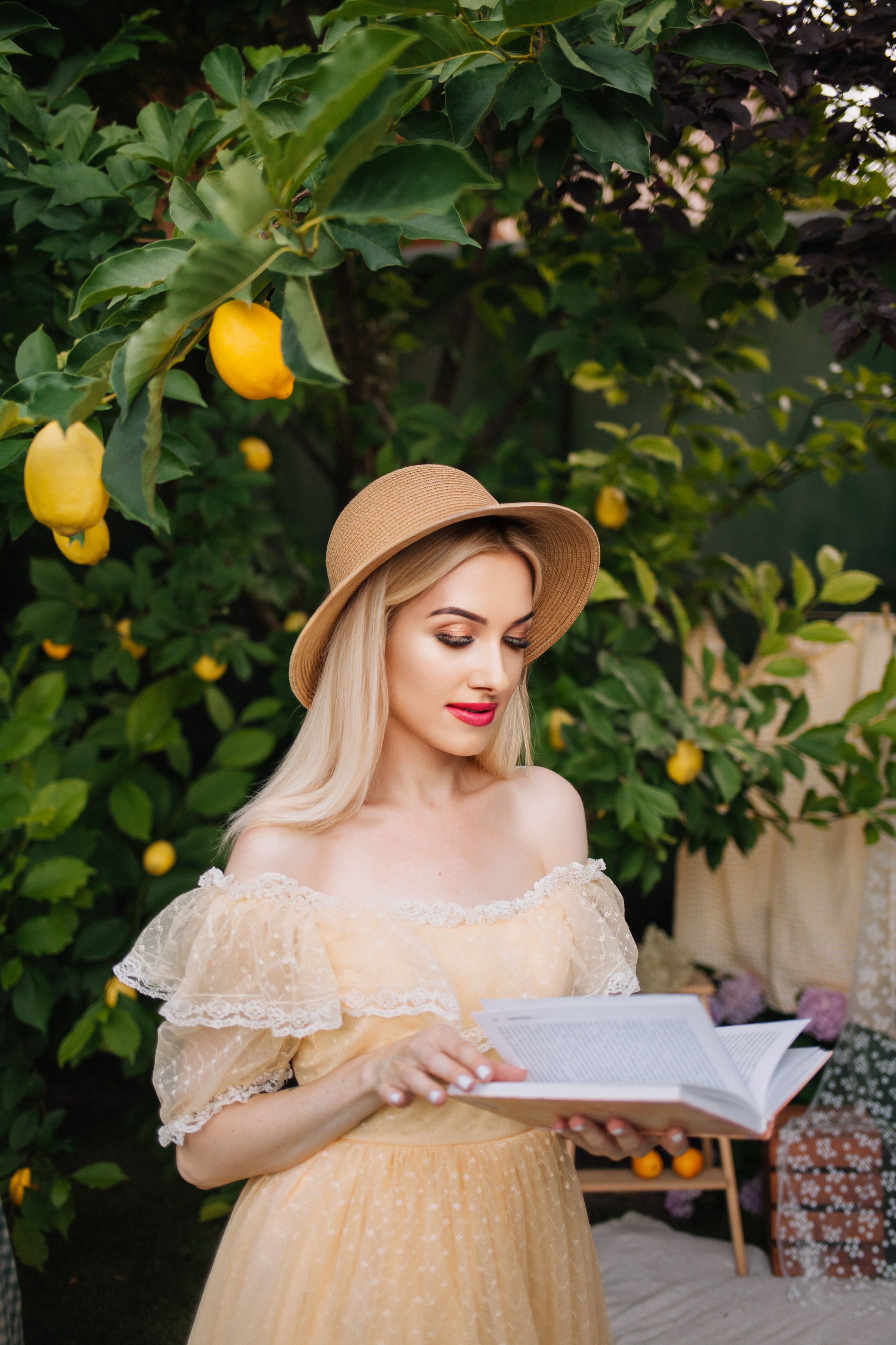 A woman in a yellow dress is reading a book · Free Stock Photo
