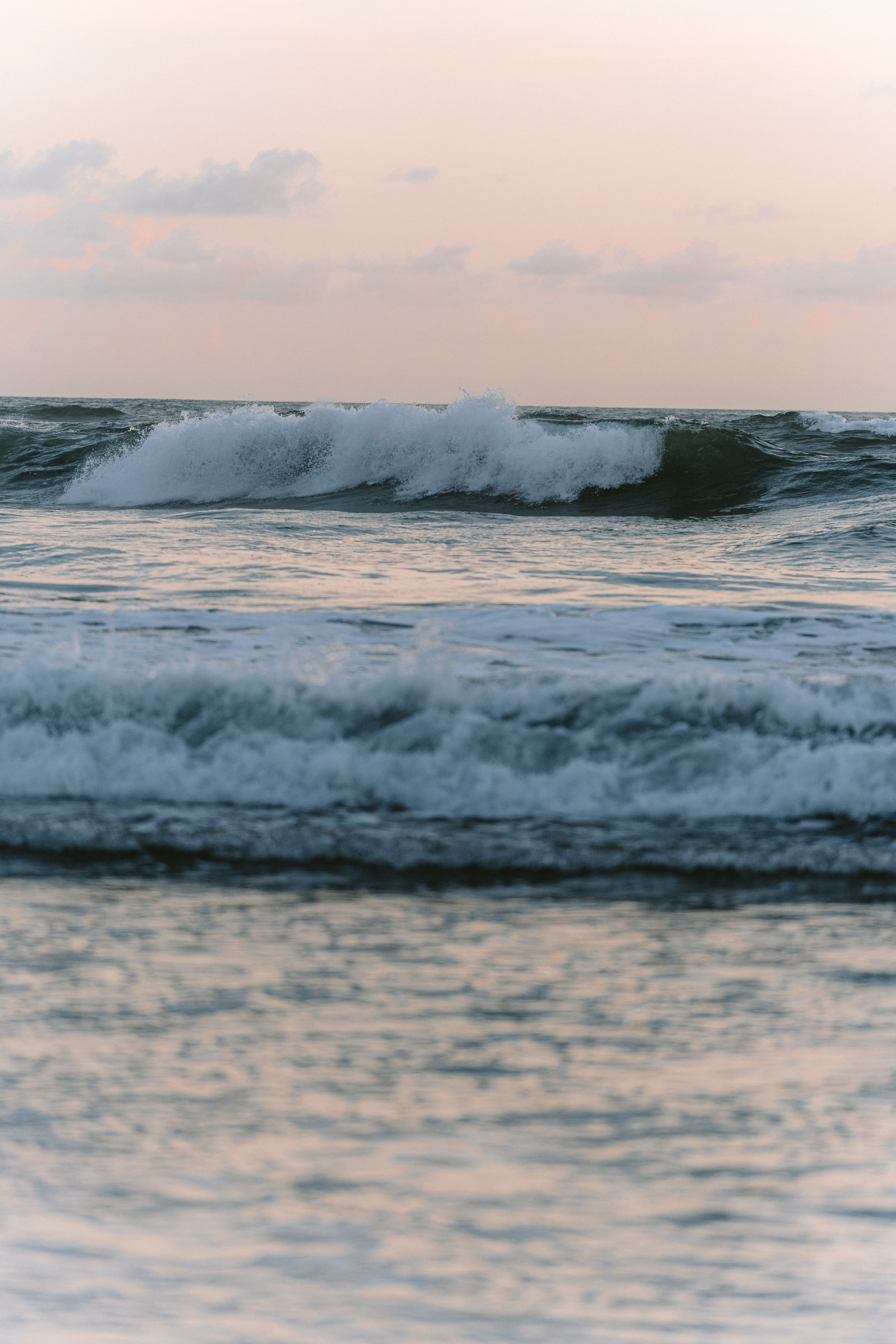 A person surfing in the ocean with a wave · Free Stock Photo