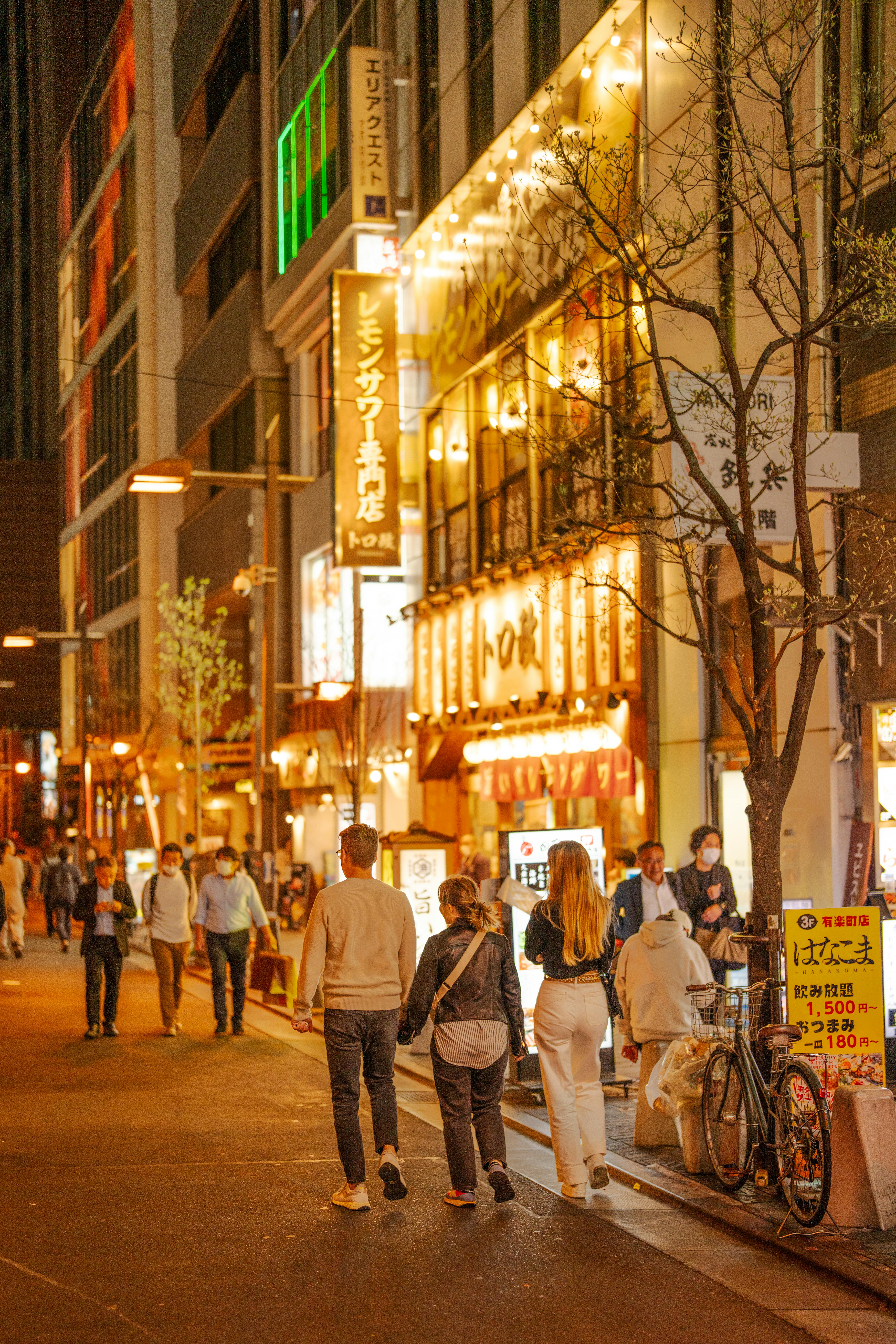 People Standing Between Buildings during Nighttime · Free Stock Photo