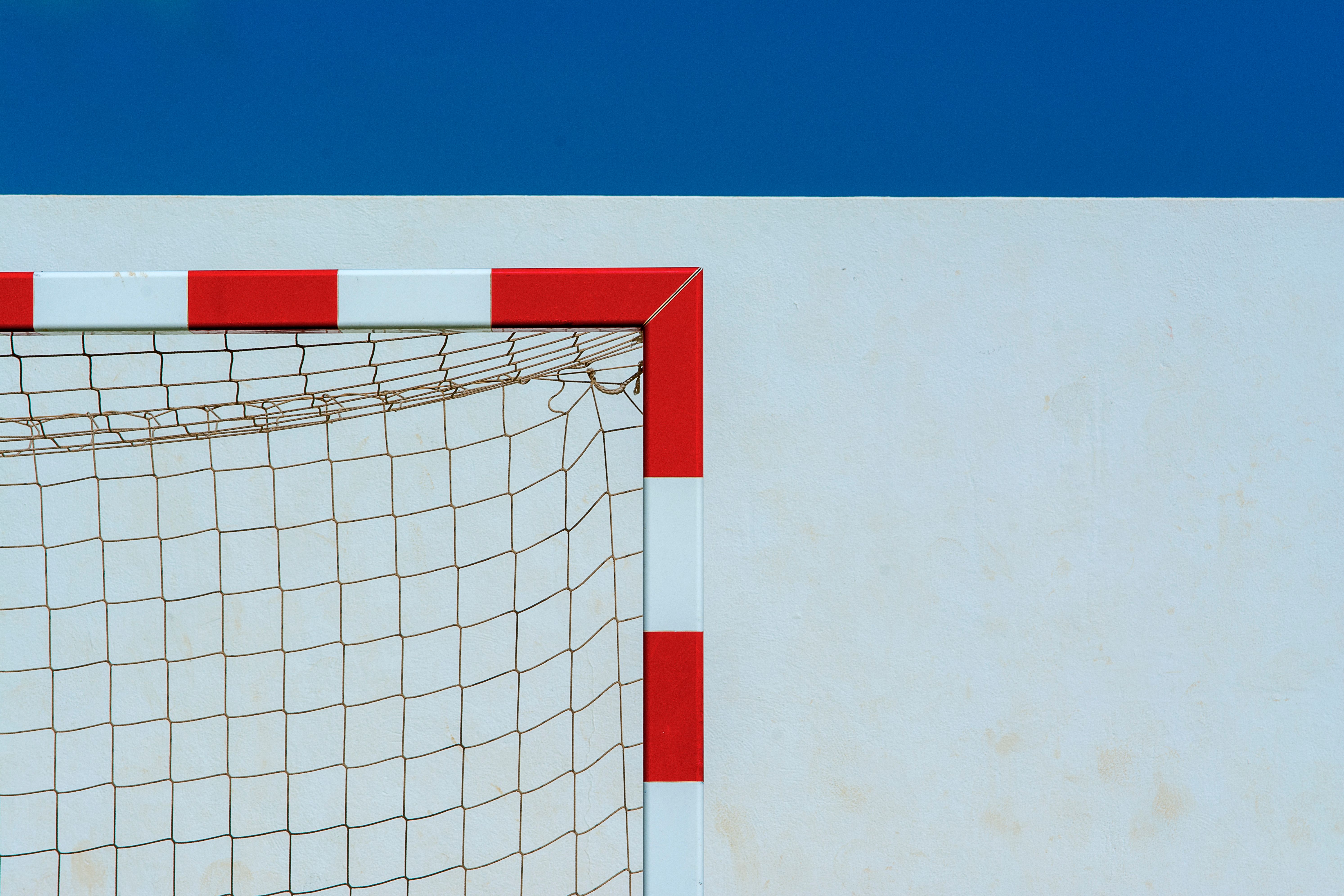 A soccer goal with a red and white stripe · Free Stock Photo