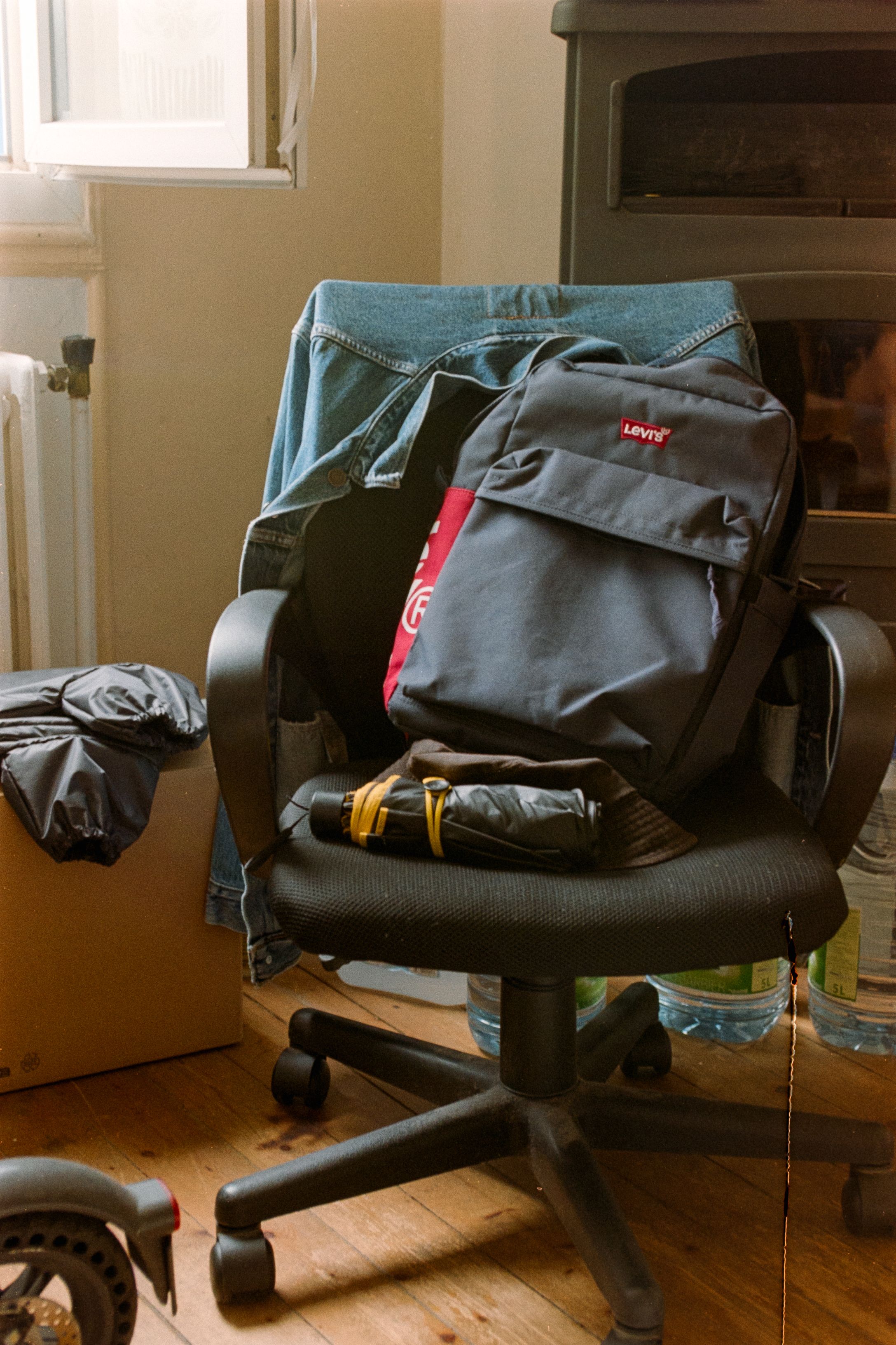 A backpack sits on a chair in a room · Free Stock Photo