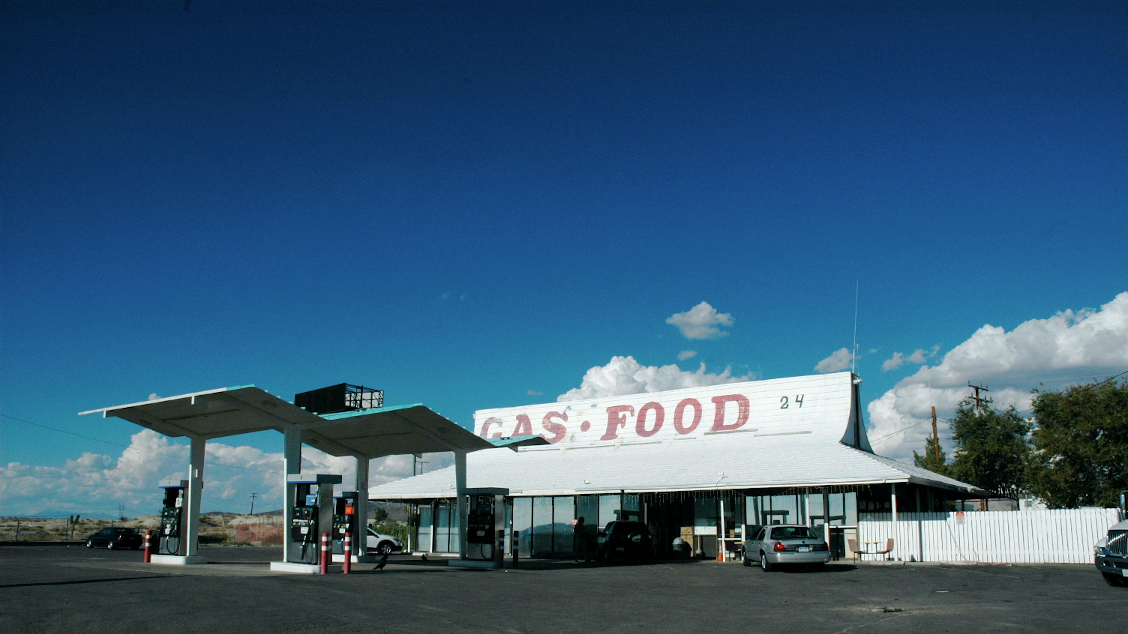 A gas station with a sign that says gas food · Free Stock Photo