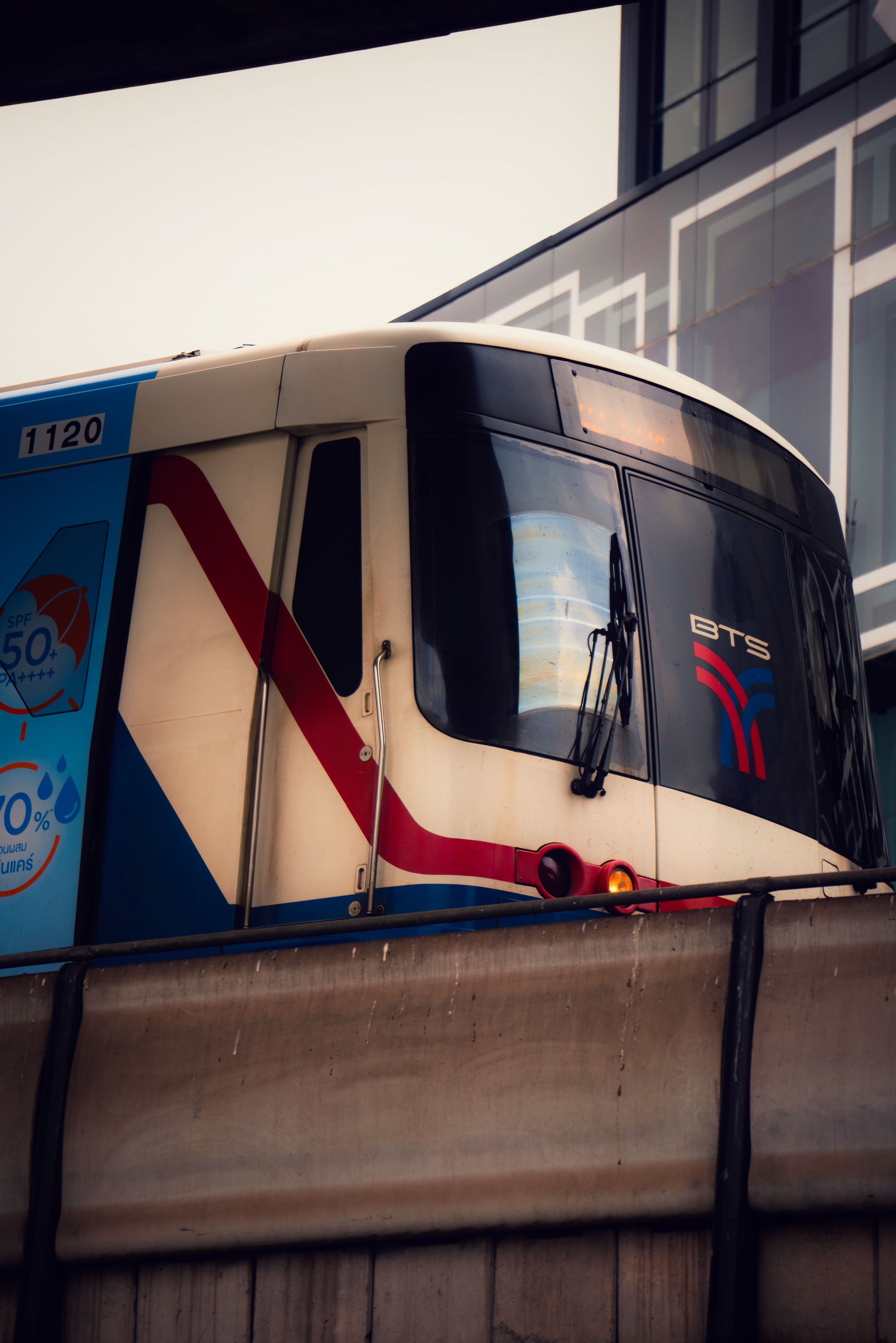 A train is traveling down a track next to a building · Free Stock Photo