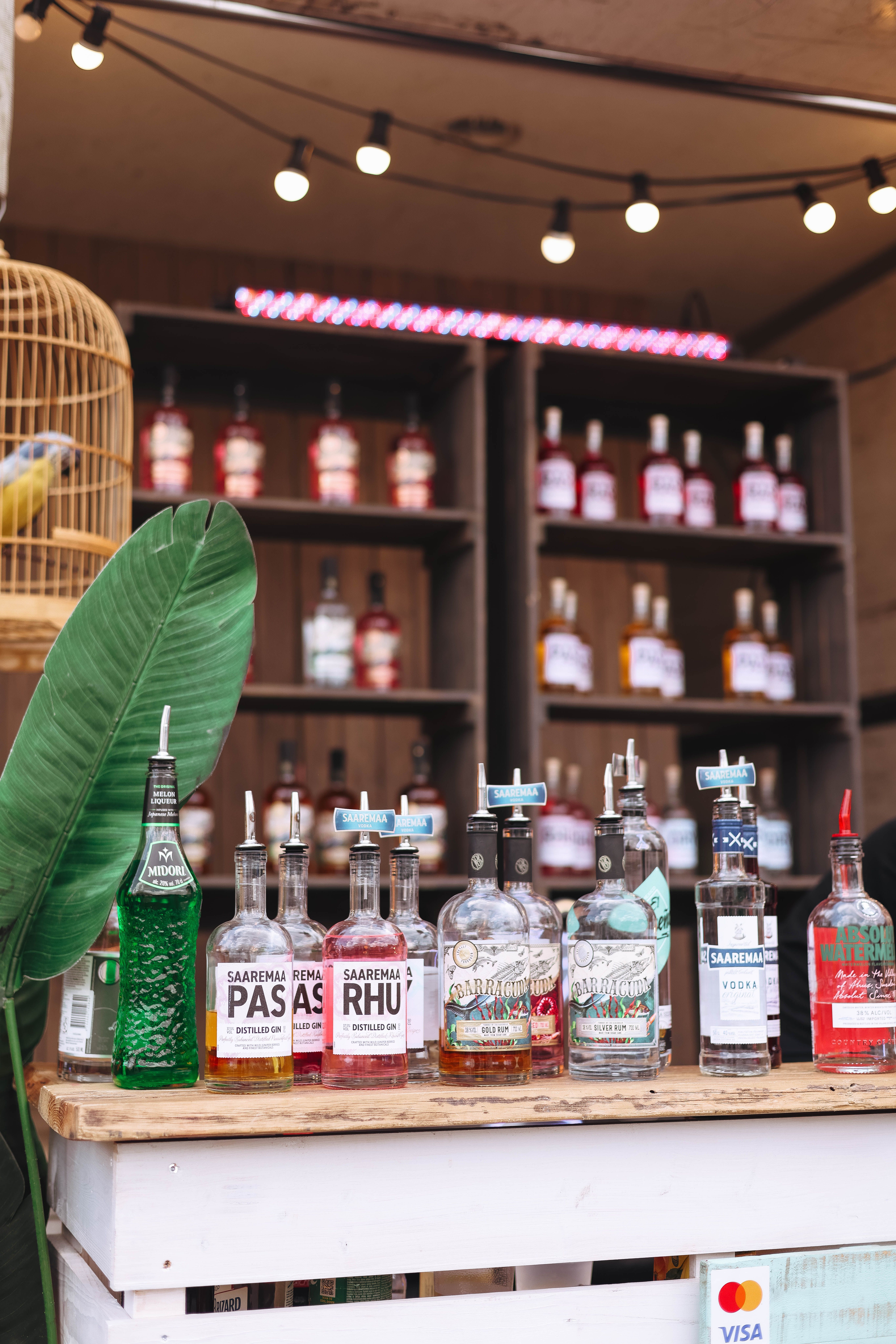 A bar with bottles of liquor on display · Free Stock Photo