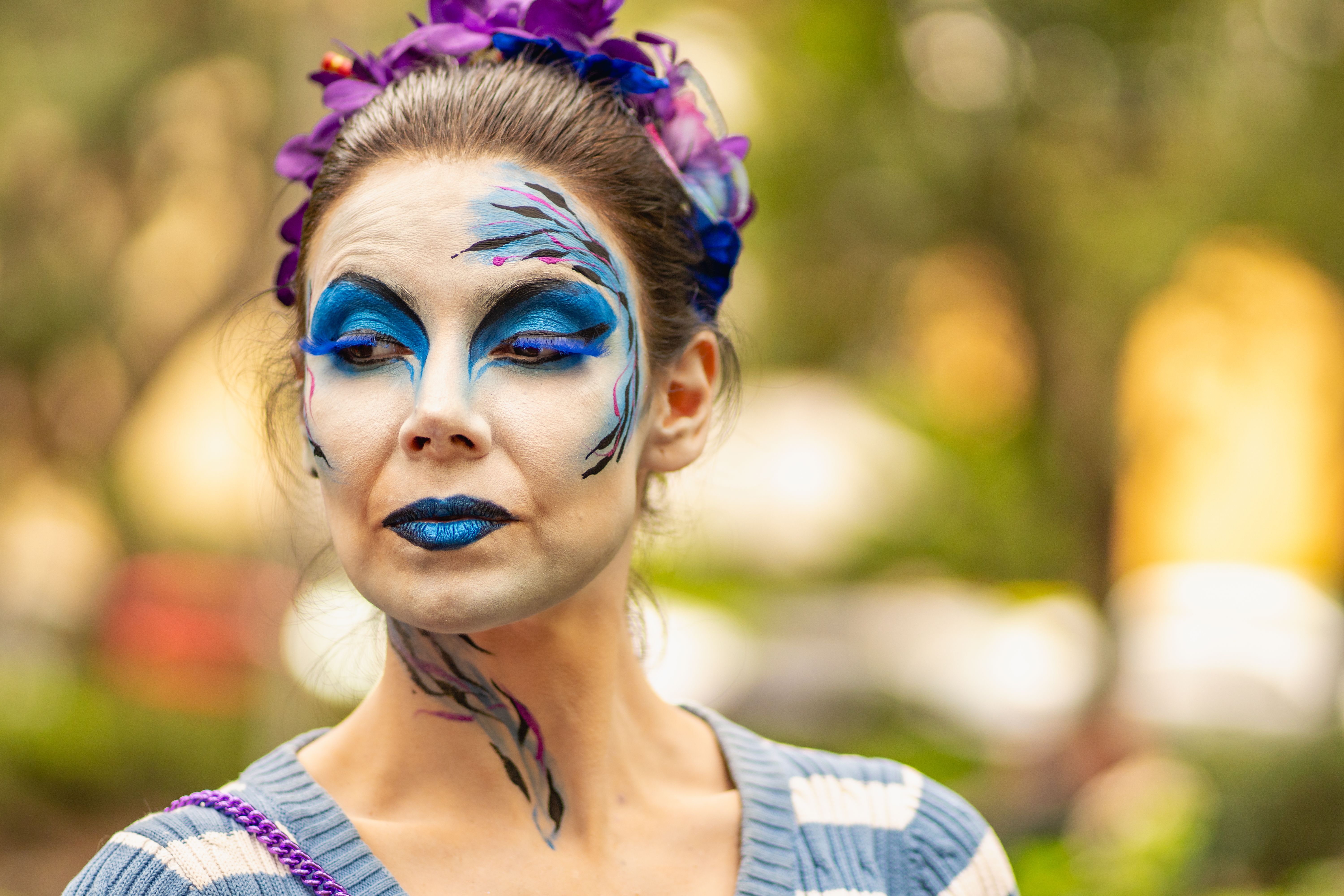 A woman with blue and purple face paint · Free Stock Photo