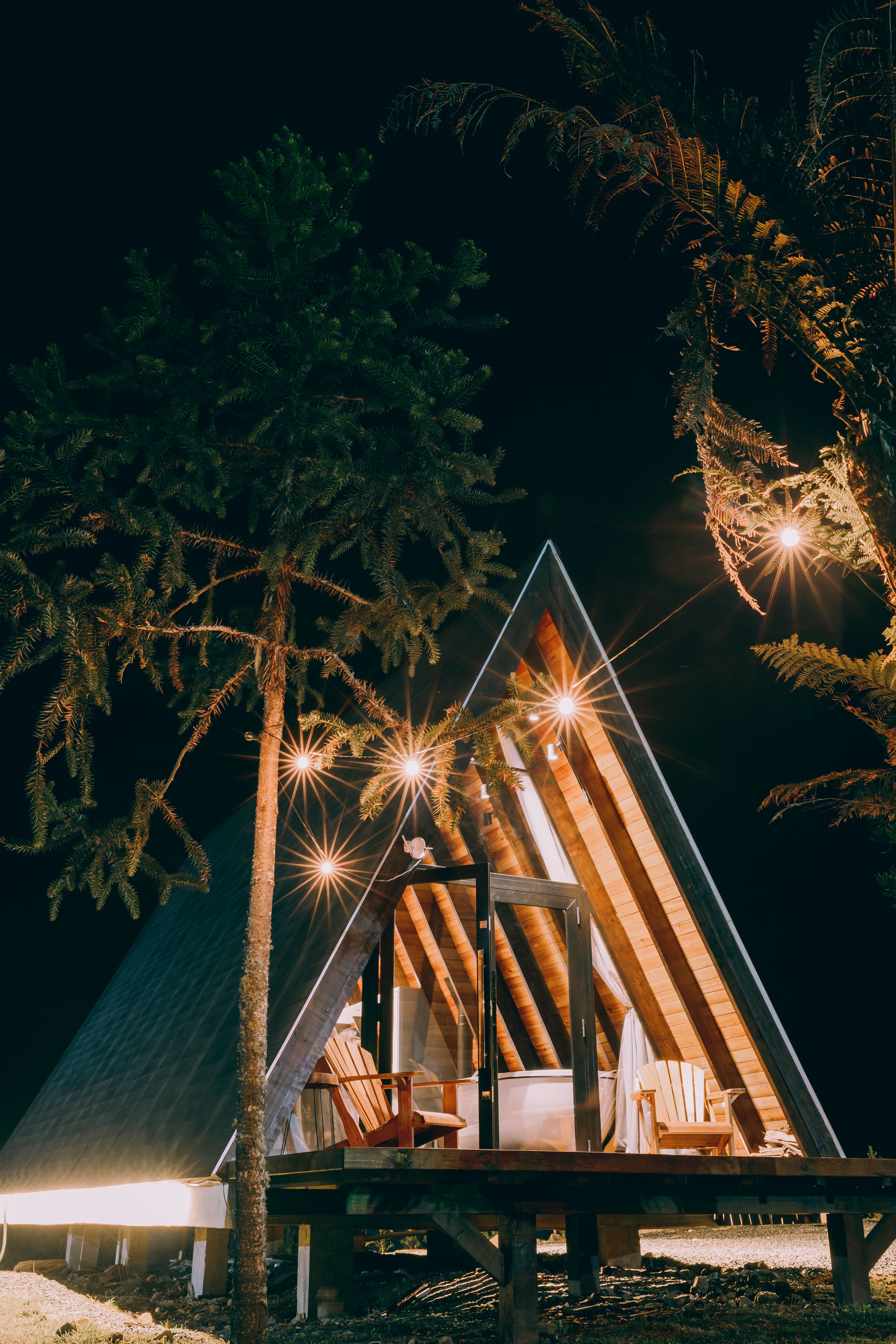 A small cabin with lights on at night · Free Stock Photo