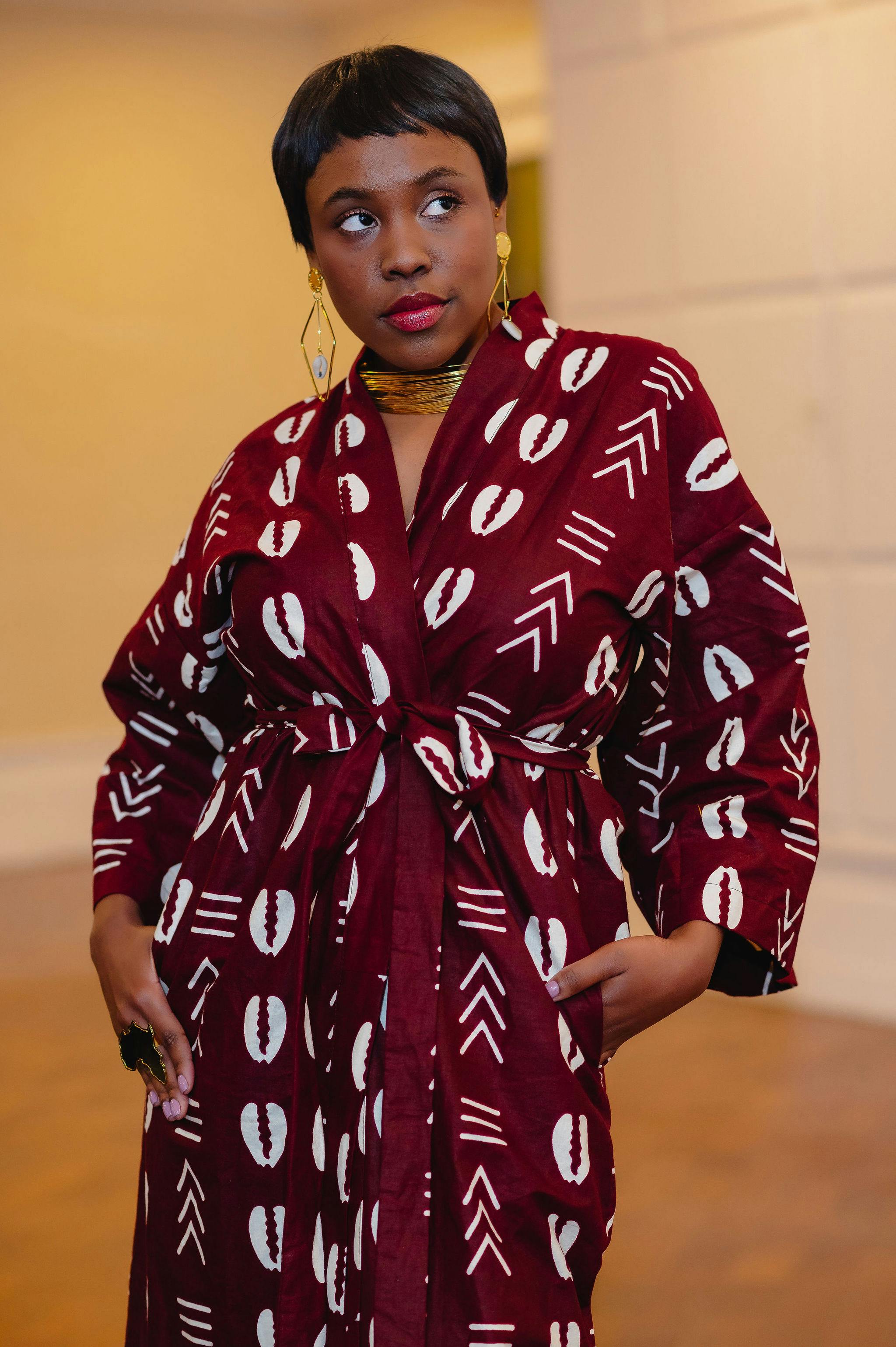 A woman in a red and white african print robe · Free Stock Photo