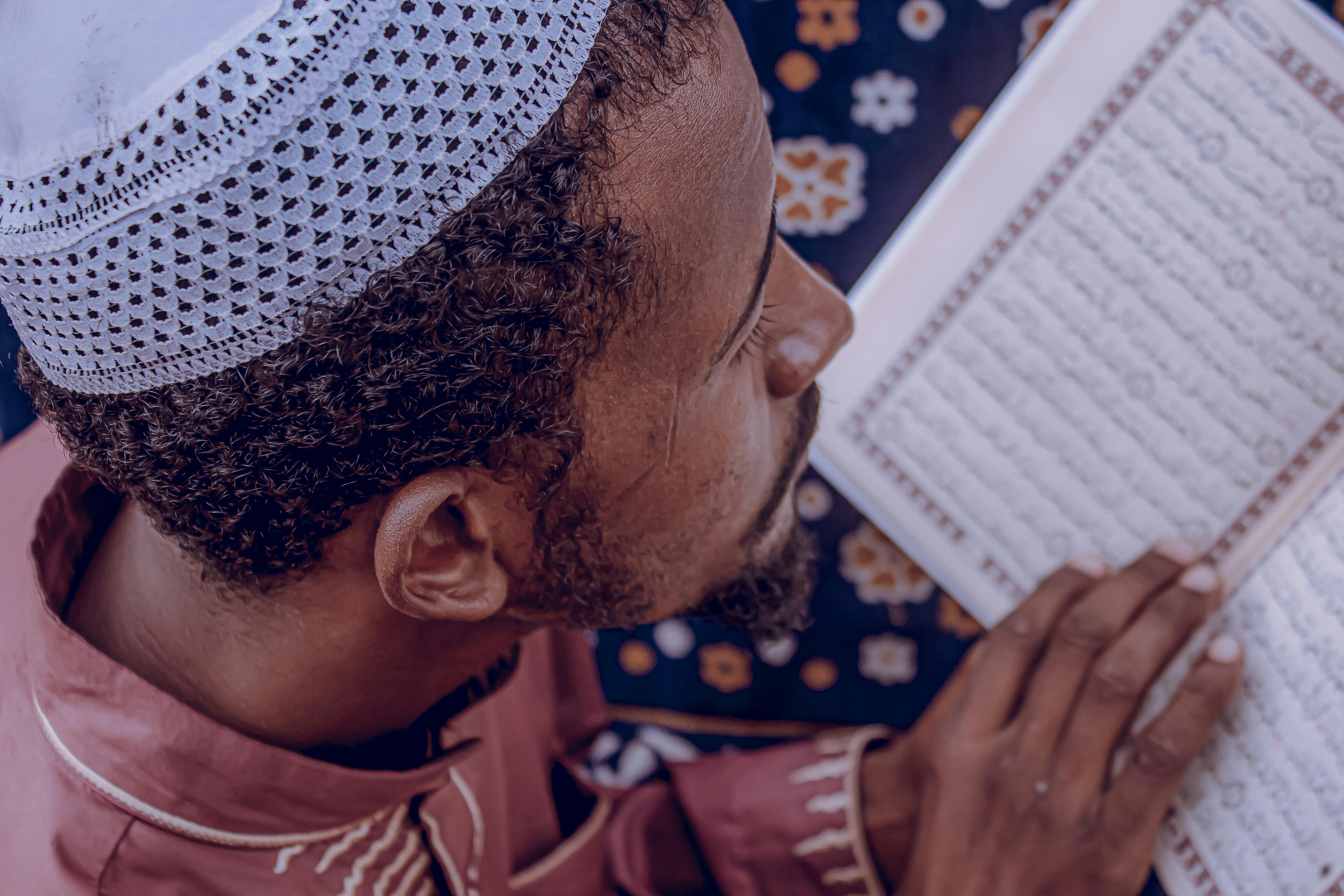A man reading the quran · Free Stock Photo