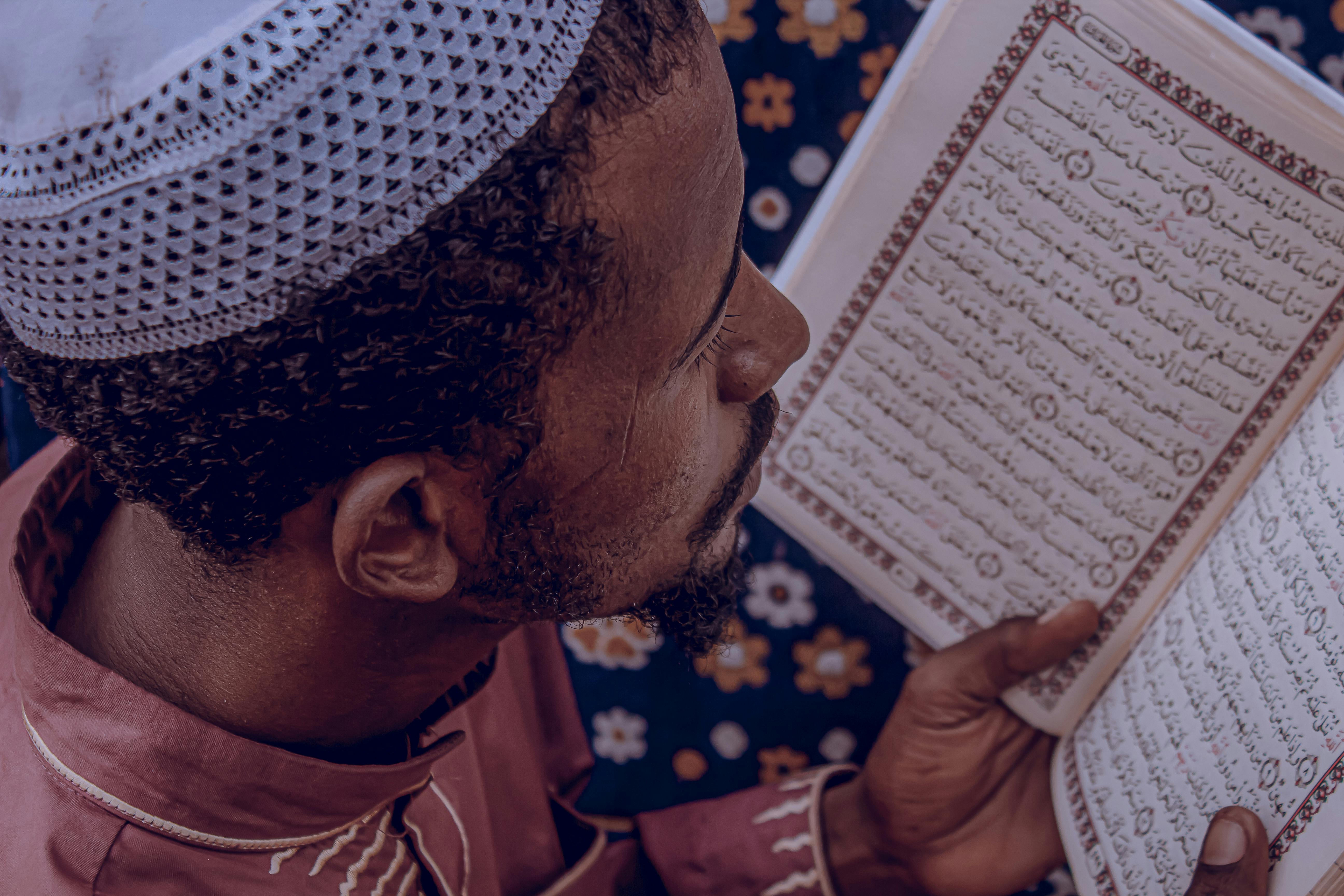 A man reading the quran in a mosque · Free Stock Photo