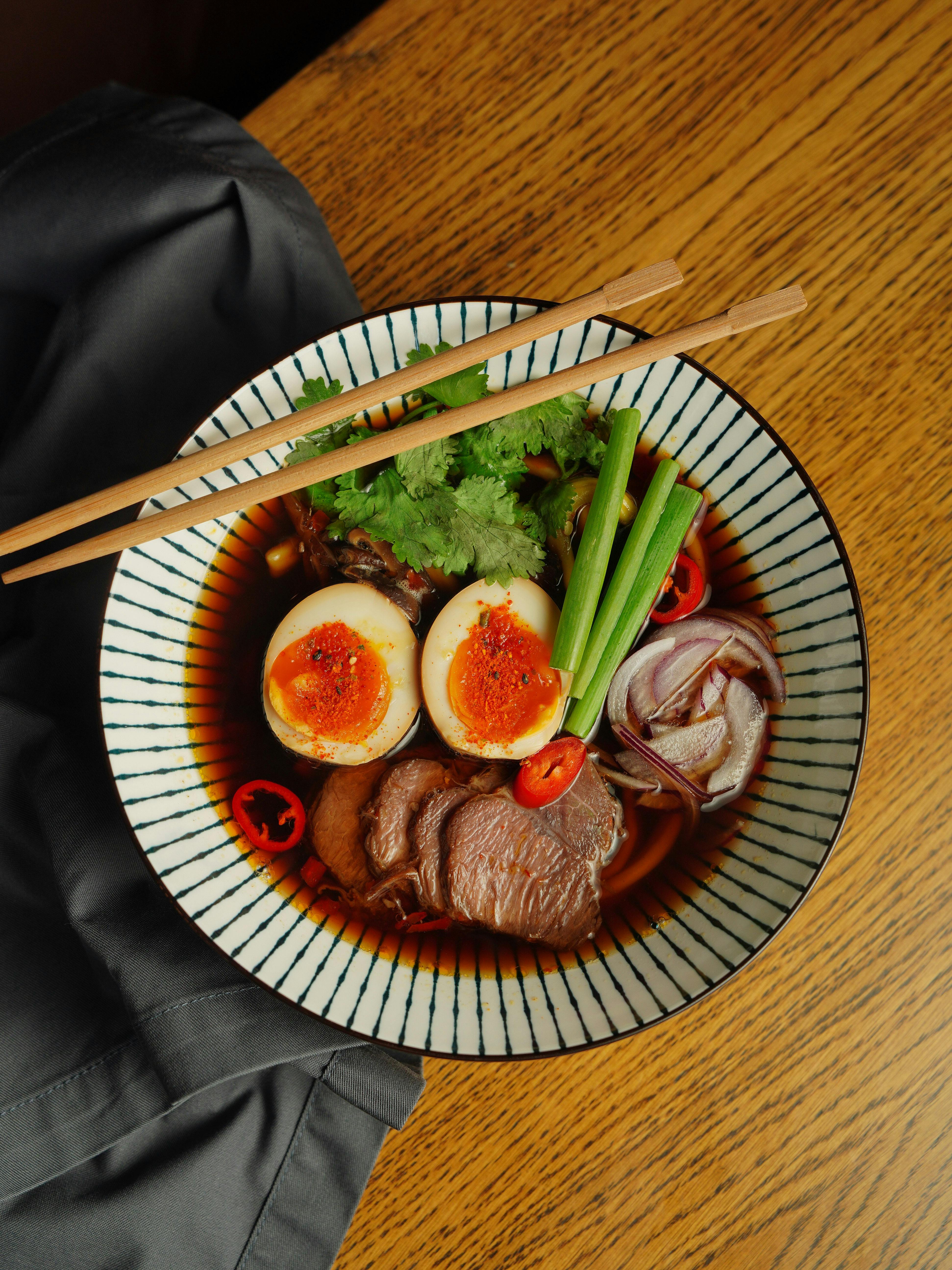 A bowl of ramen with meat and chopsticks · Free Stock Photo