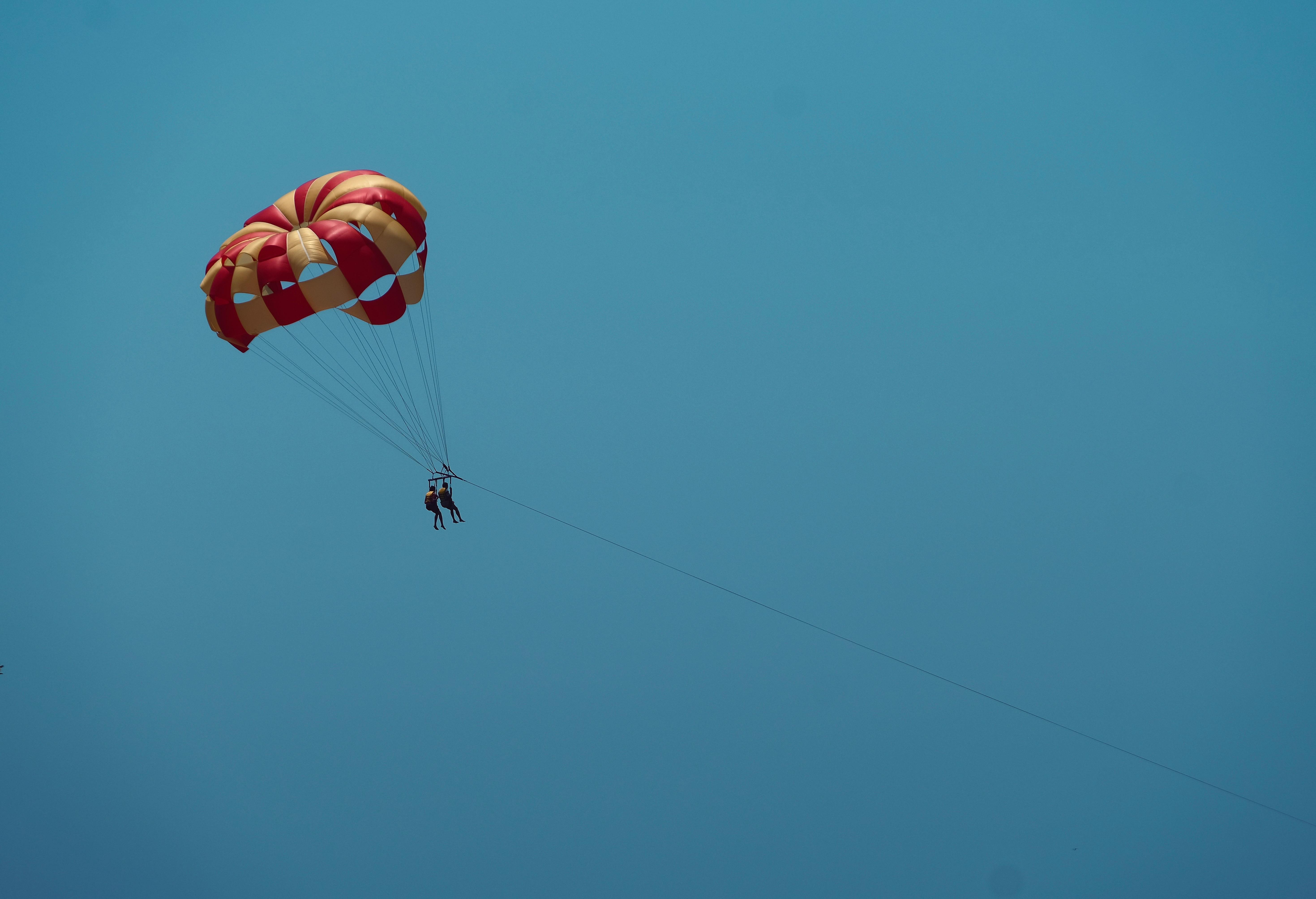 A person parasailing in the sky · Free Stock Photo