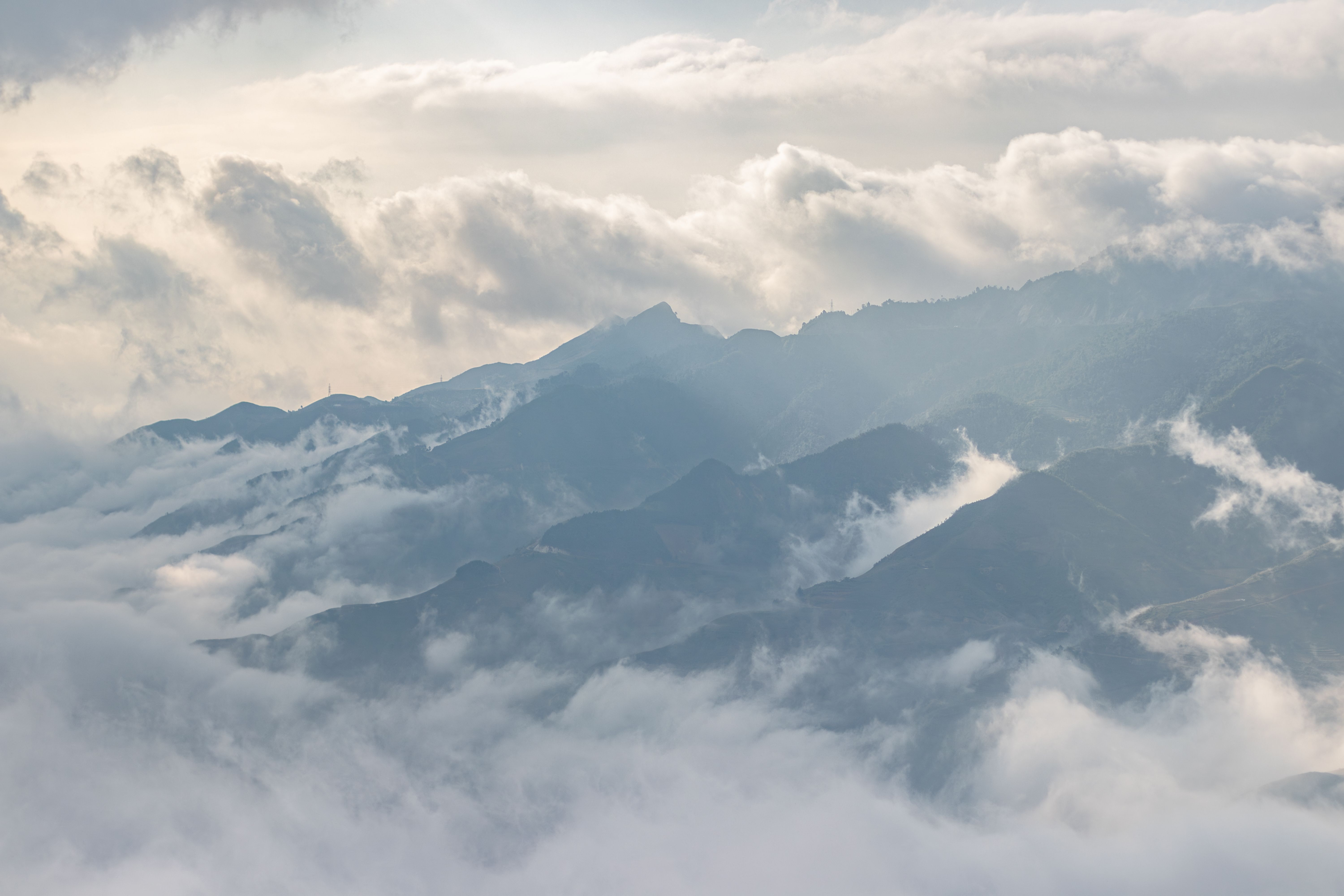 A view of mountains and clouds from above · Free Stock Photo