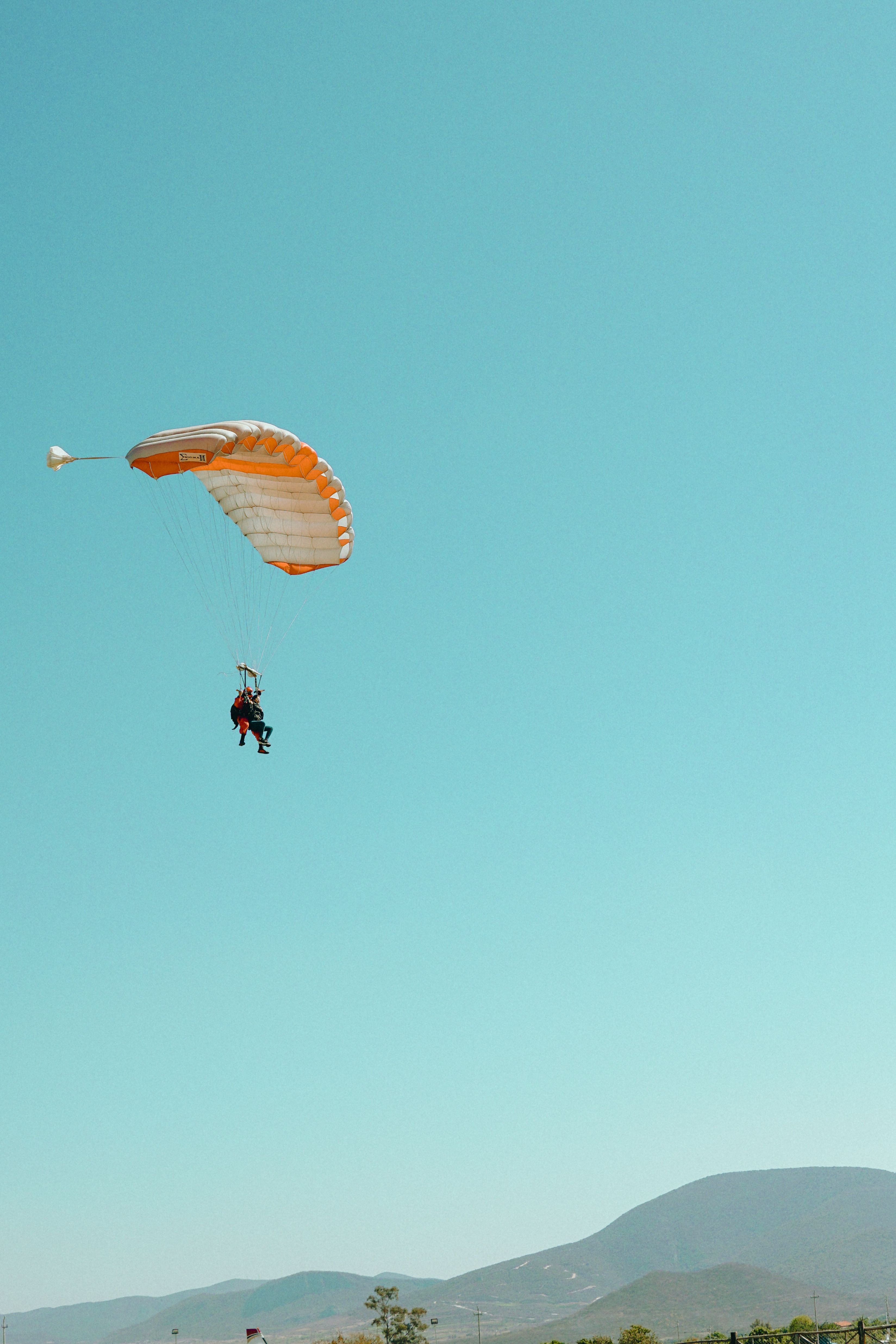 A person is flying a parachute in the sky · Free Stock Photo