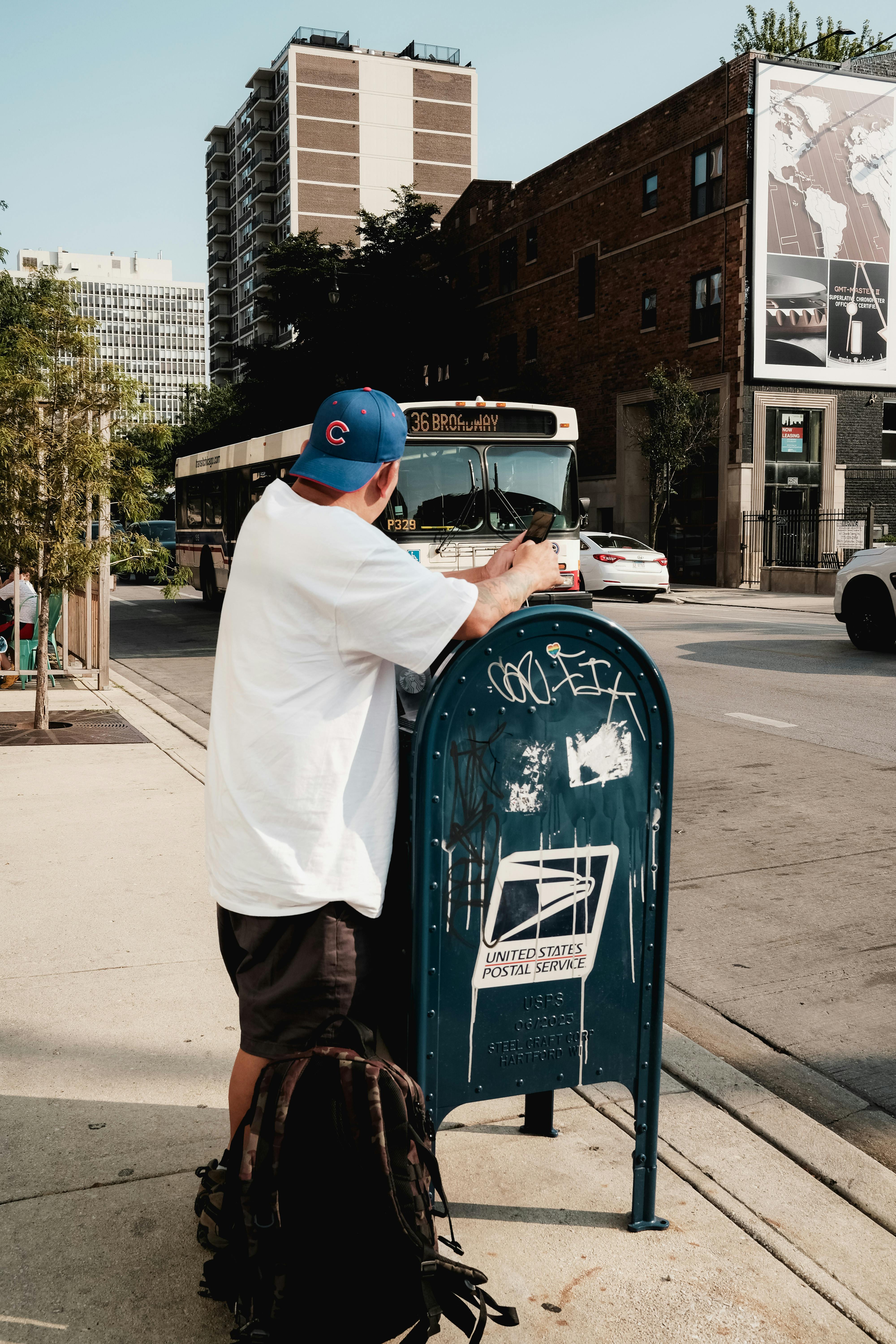 A man is standing in front of a mailbox · Free Stock Photo