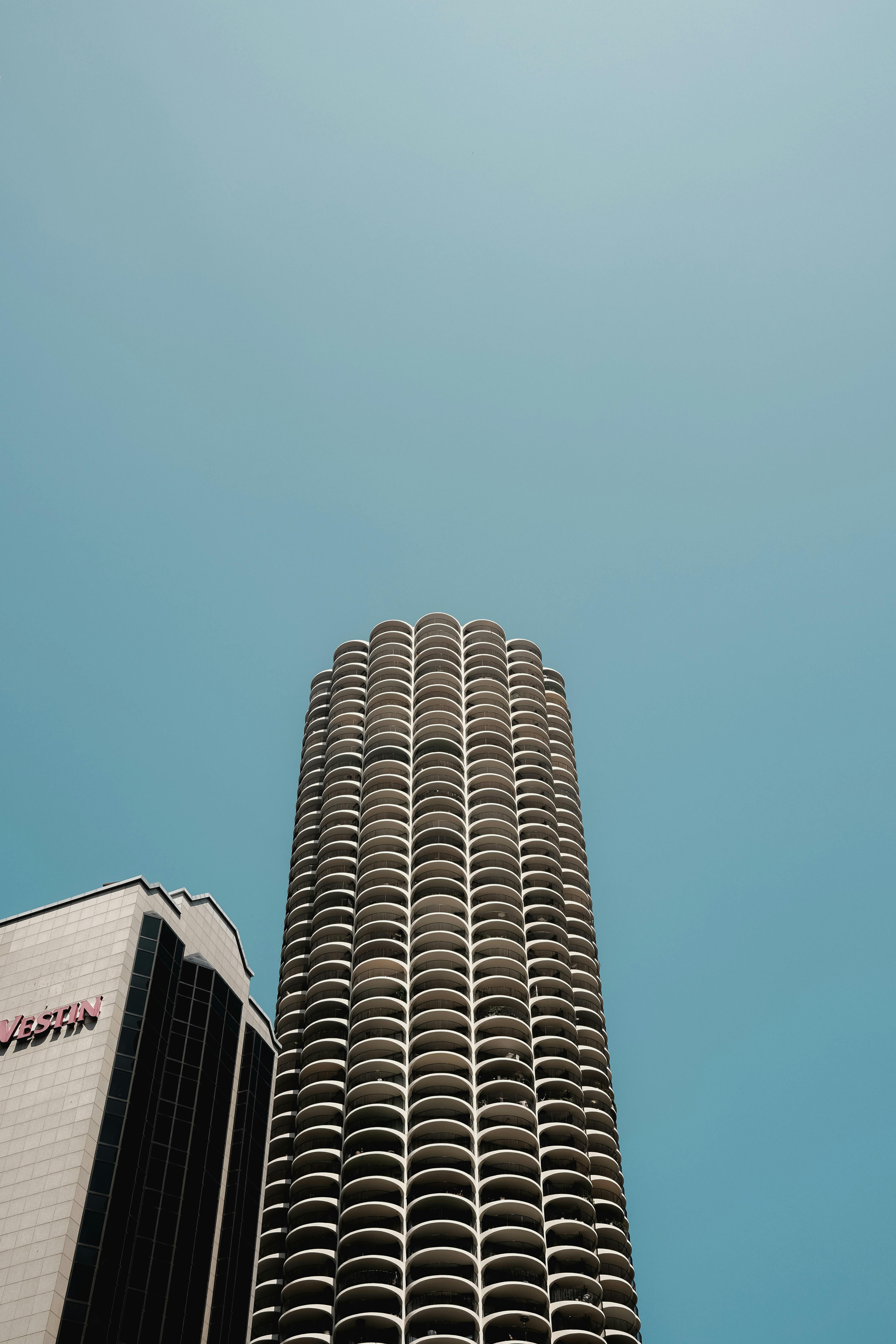 A tall building with a blue sky in the background · Free Stock Photo