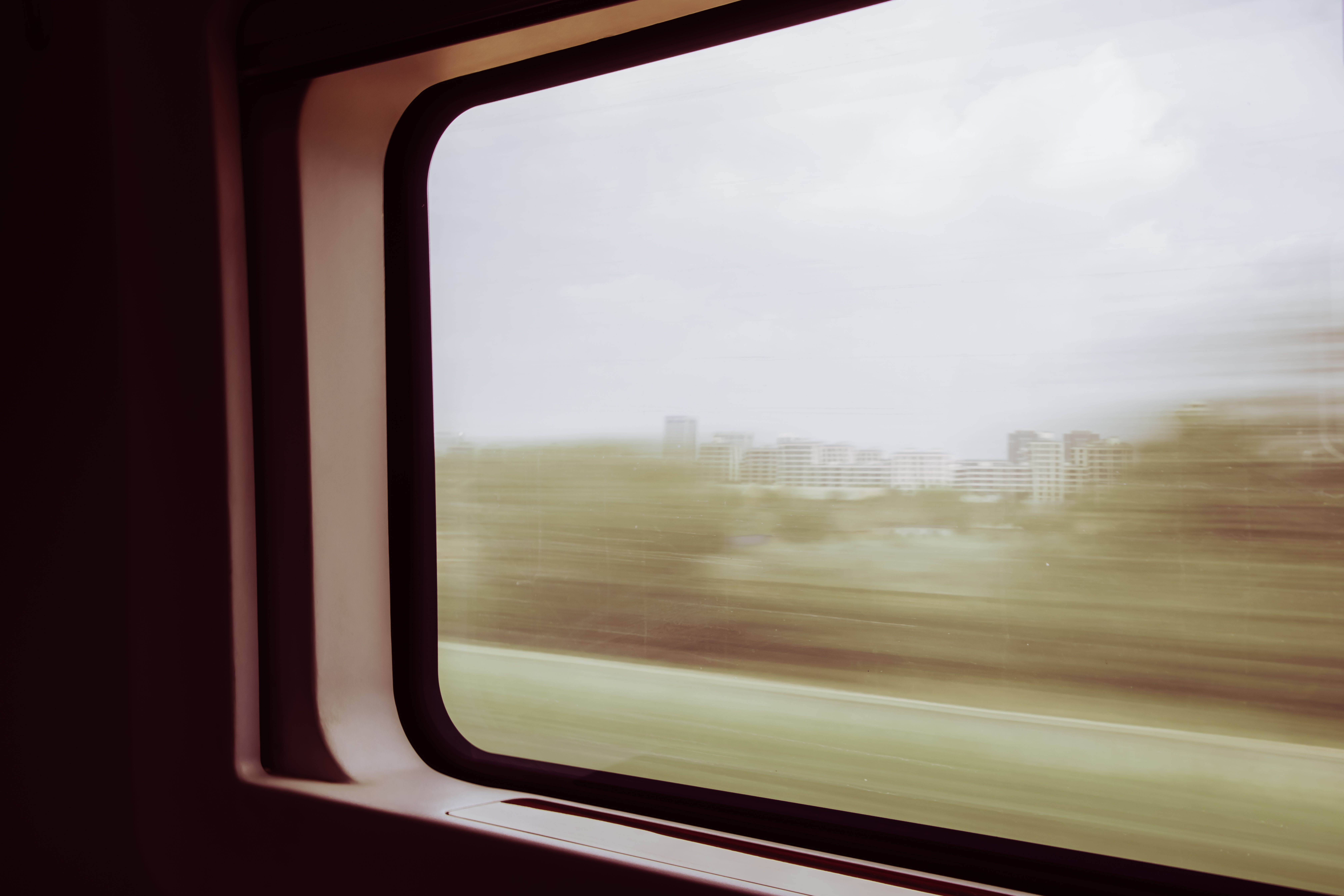 A train window with a view of a city · Free Stock Photo