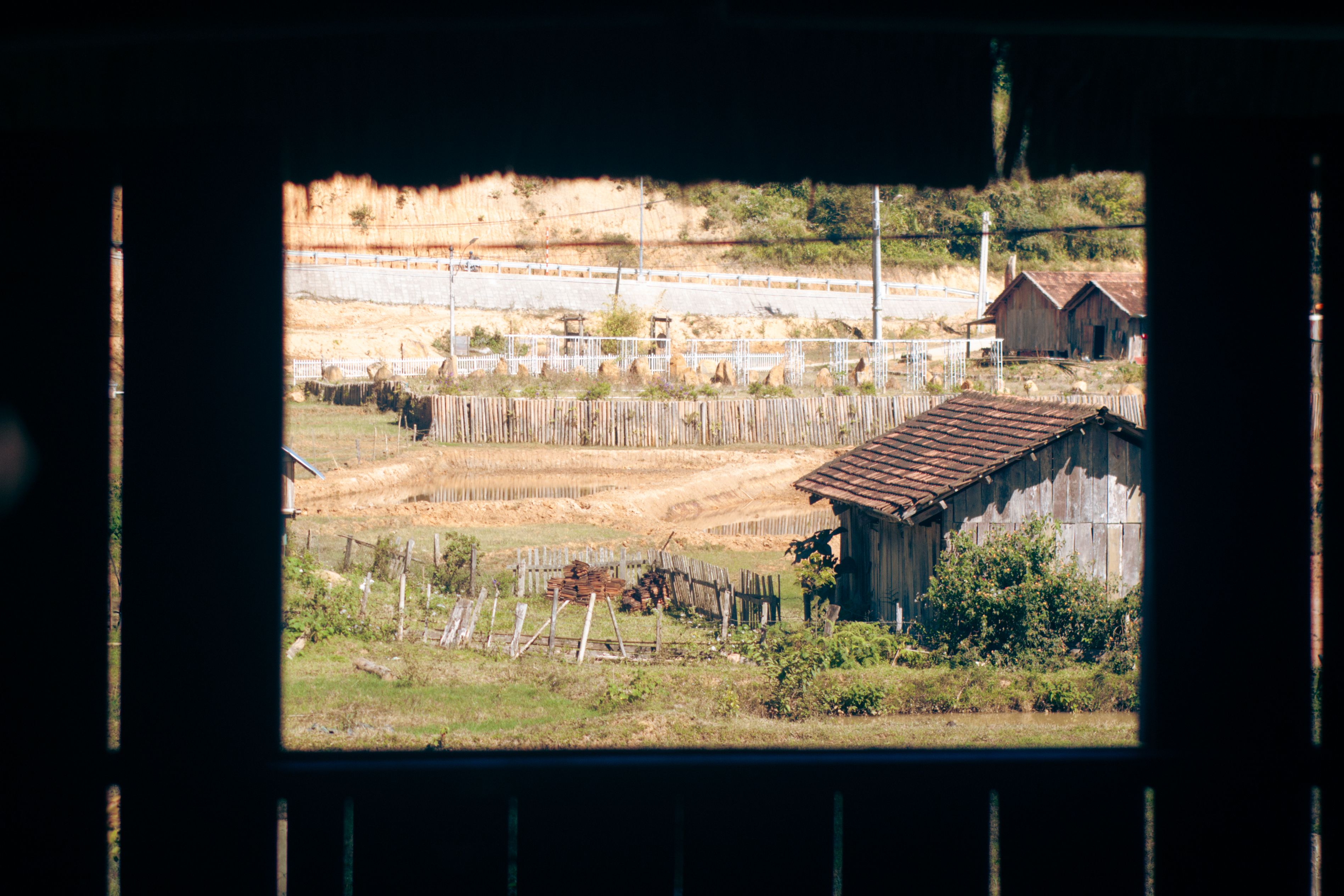 A view of a farm from a window in a house · Free Stock Photo