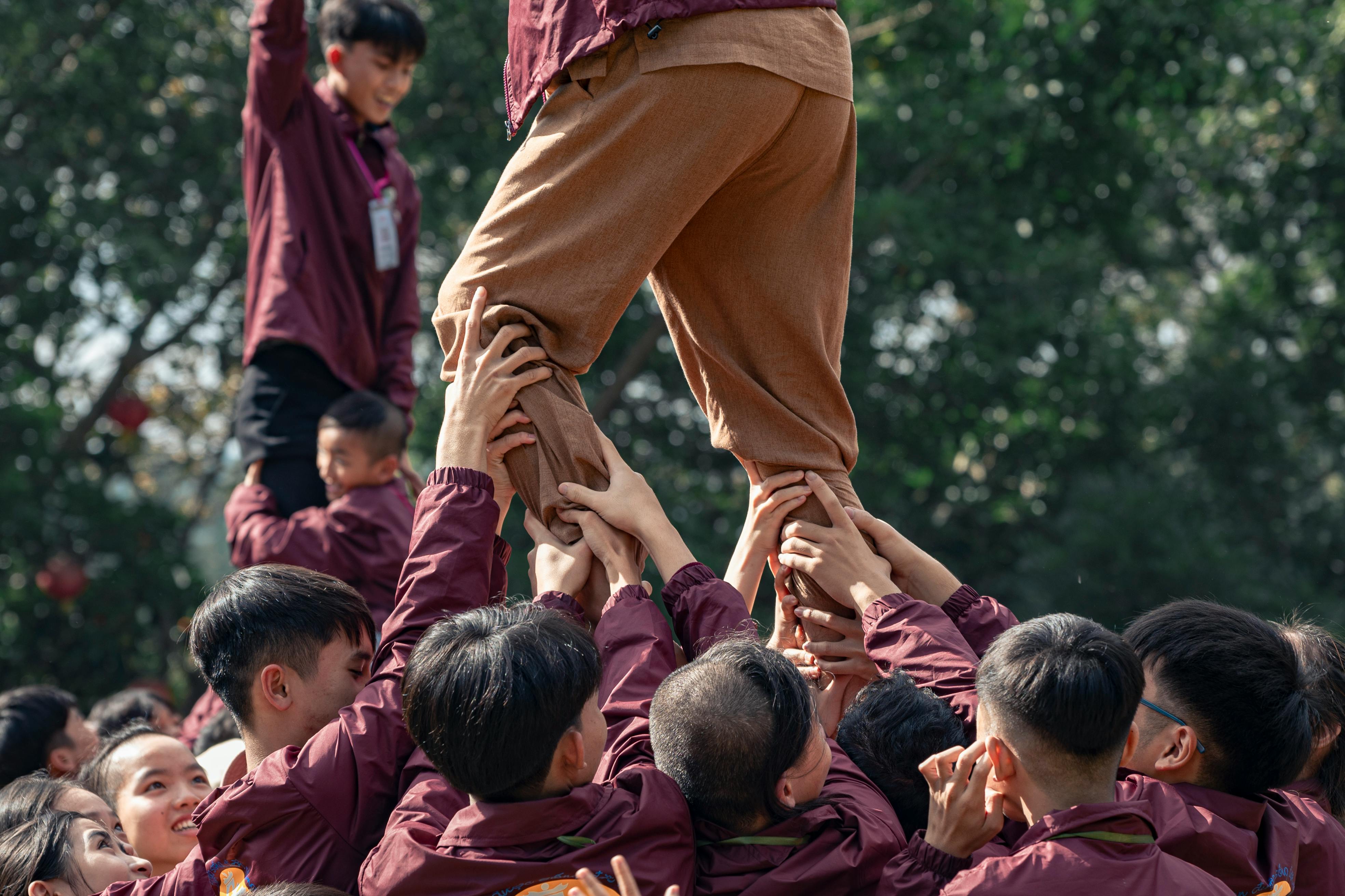 A group of people standing on top of each other · Free Stock Photo