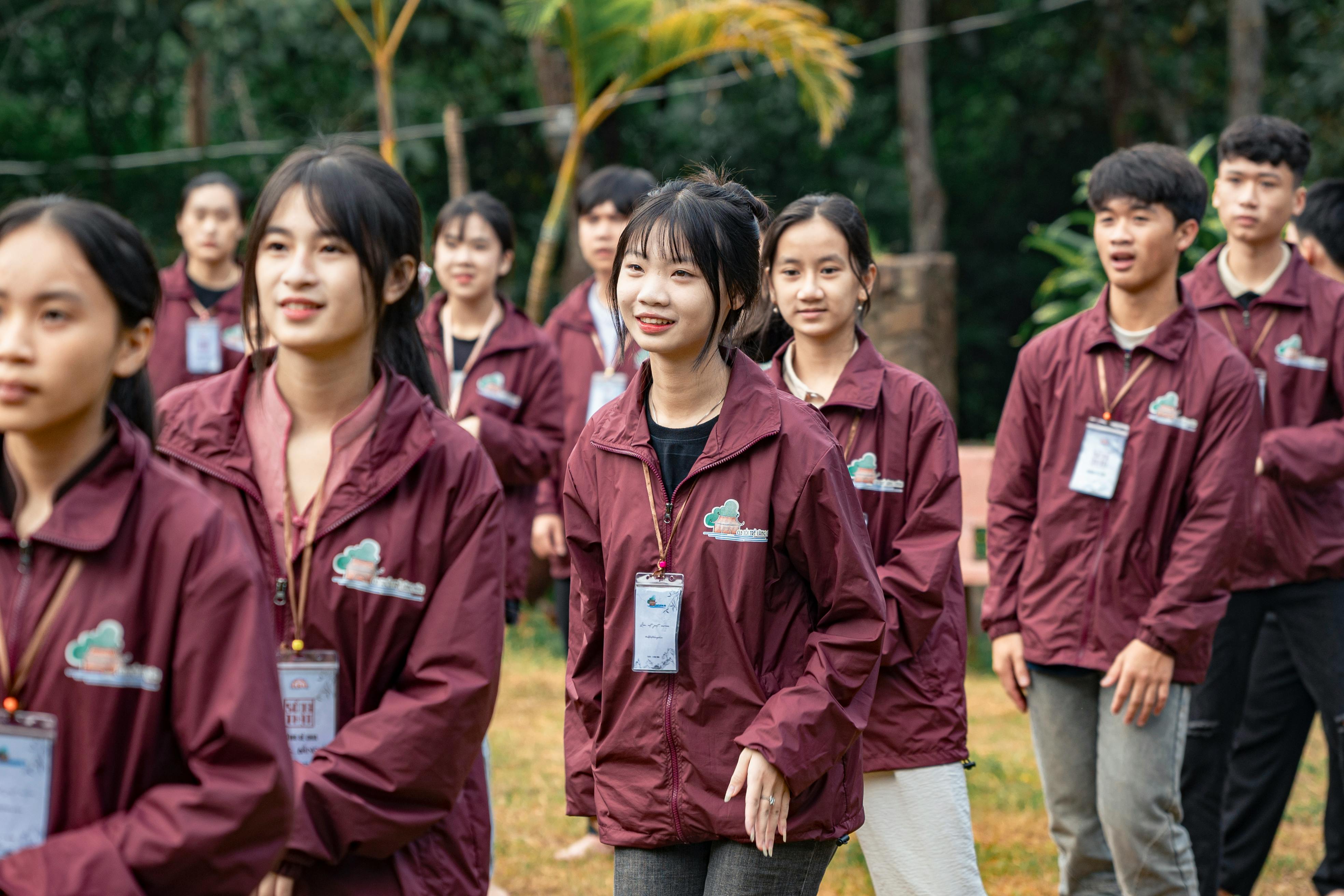 A group of young people in maroon jackets · Free Stock Photo