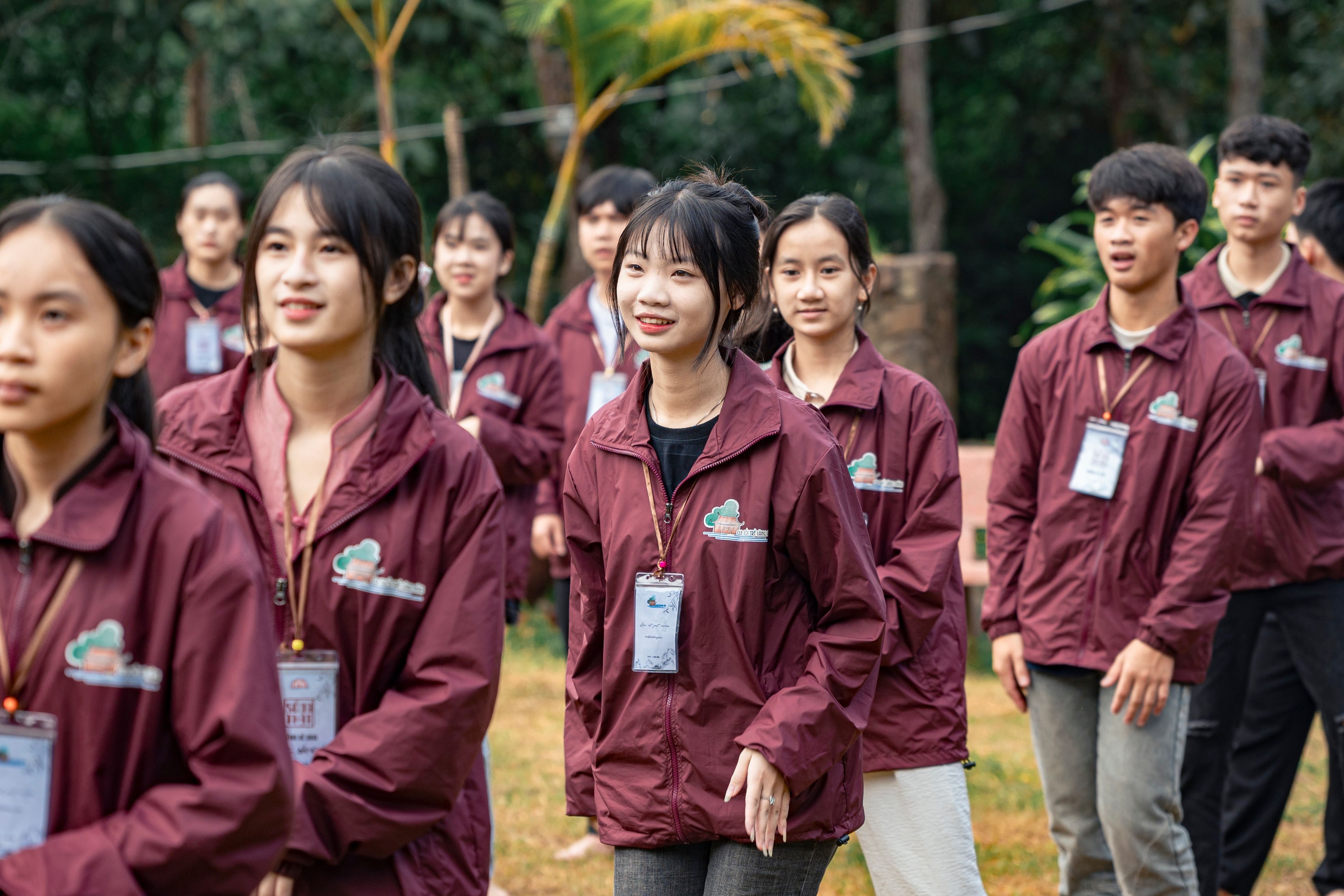 A group of young people in maroon jackets · Free Stock Photo