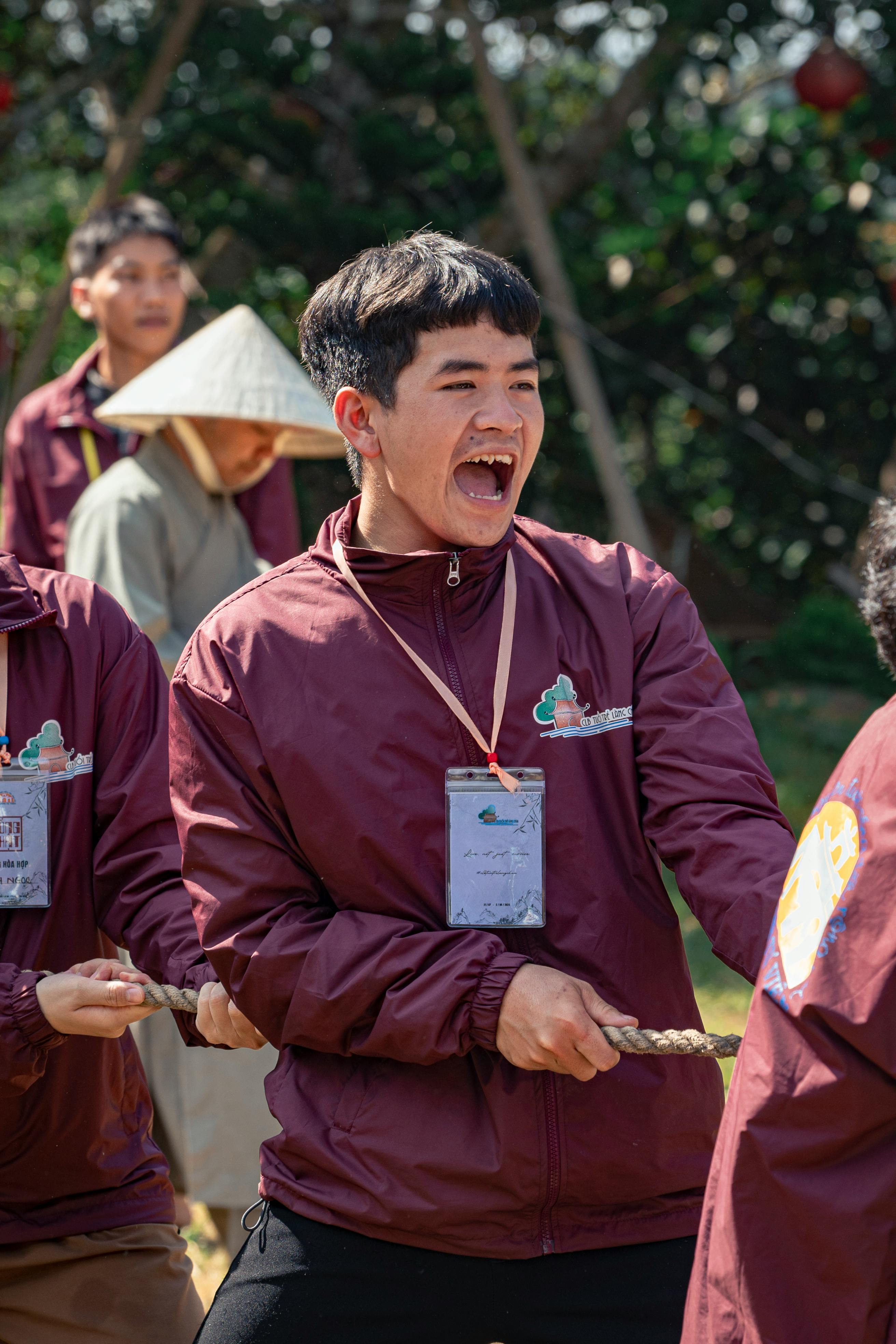 A group of young men in maroon jackets are playing with a rope · Free ...