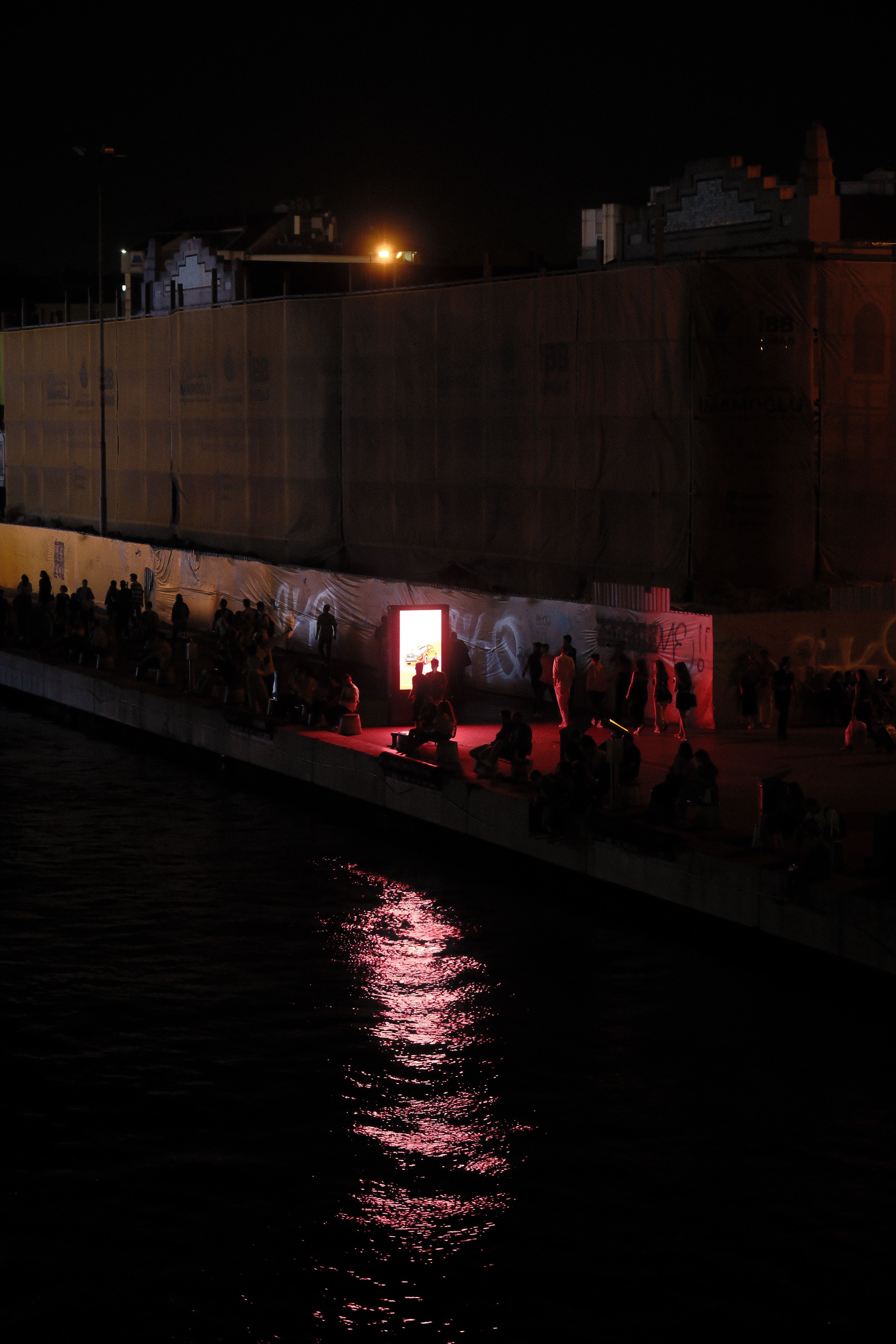 A group of people standing on the dock at night · Free Stock Photo