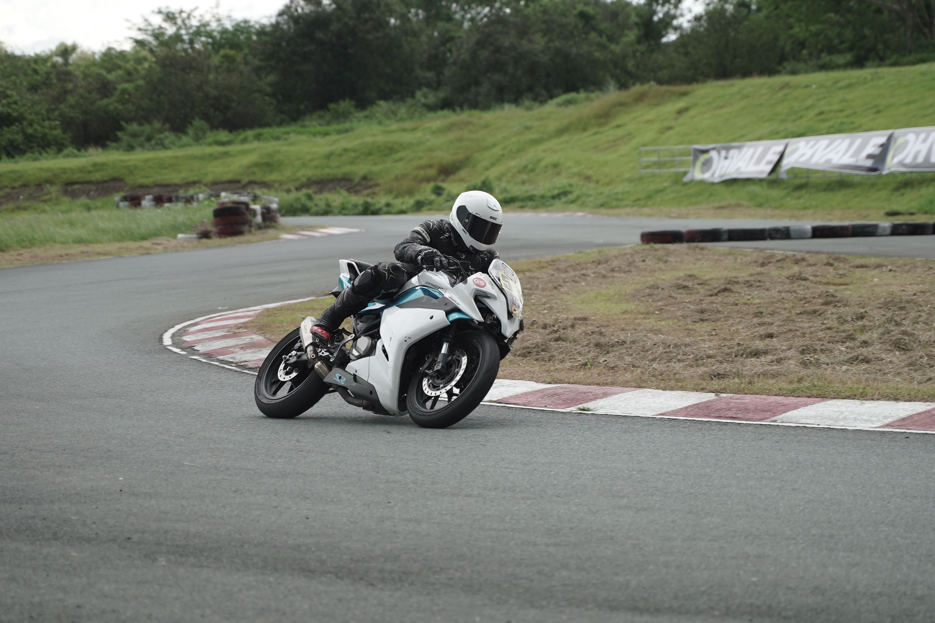 A person riding a motorcycle on a track · Free Stock Photo