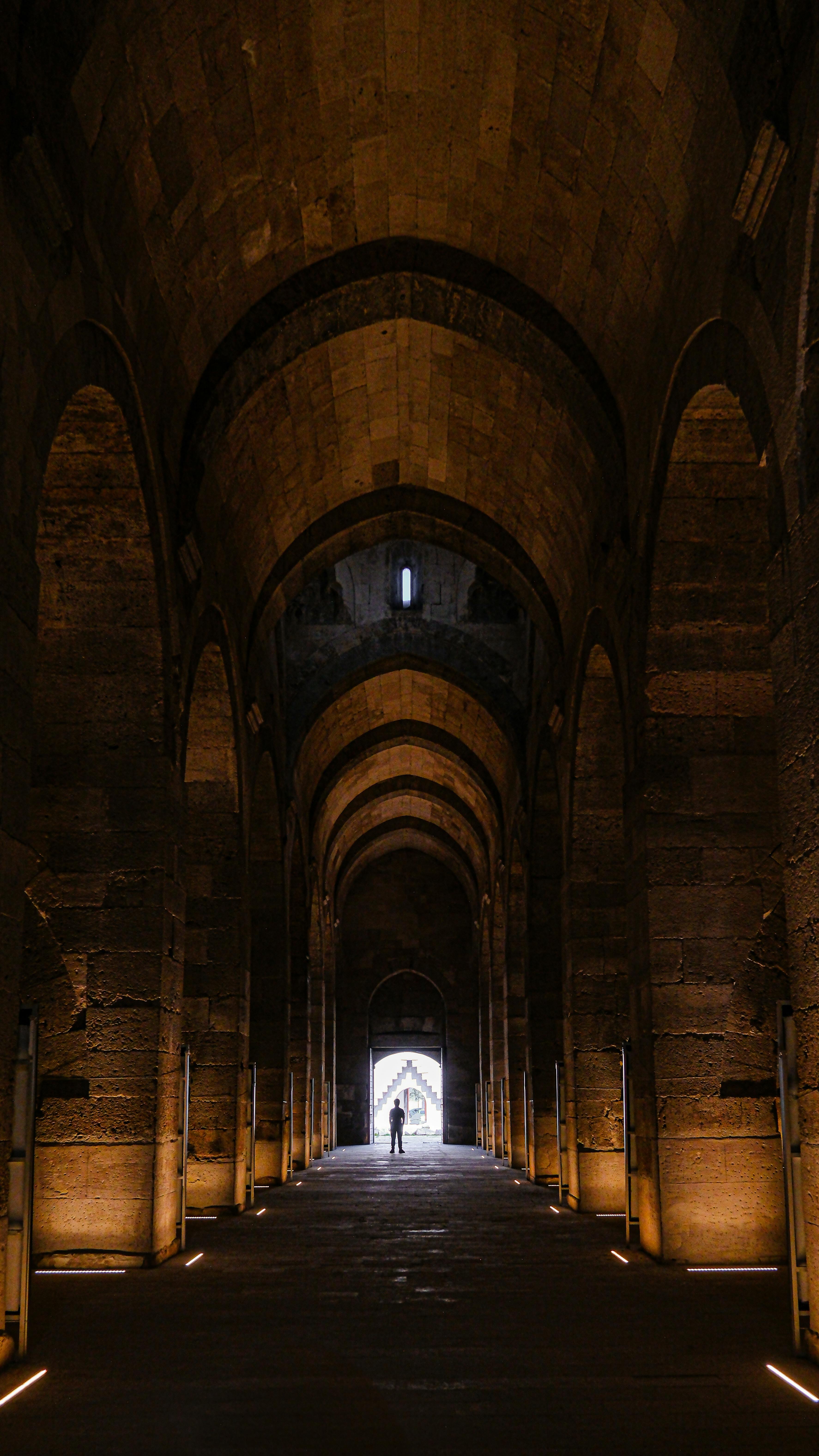 The inside of an arched building with light coming through · Free Stock ...