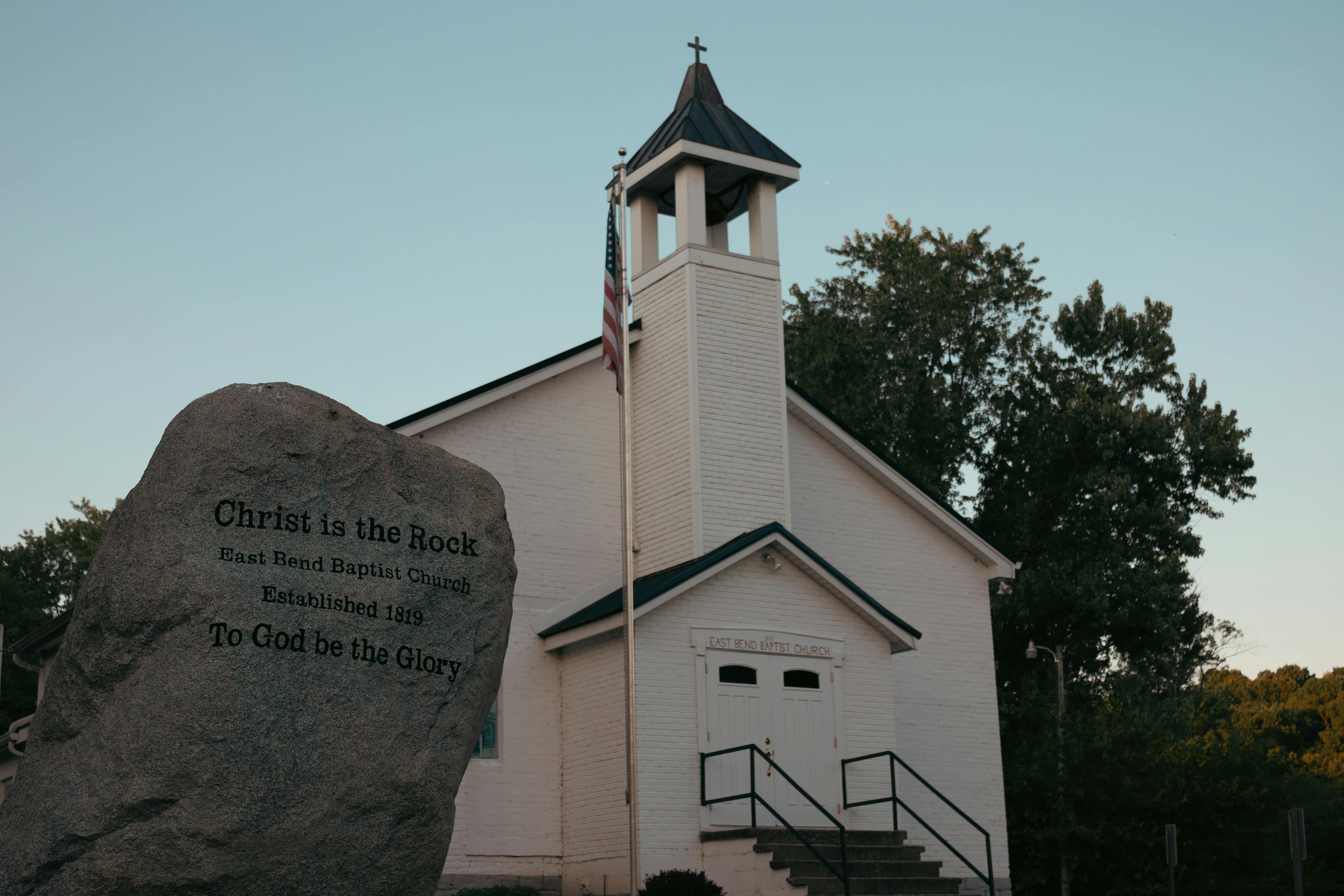 A church with a large rock in front of it · Free Stock Photo