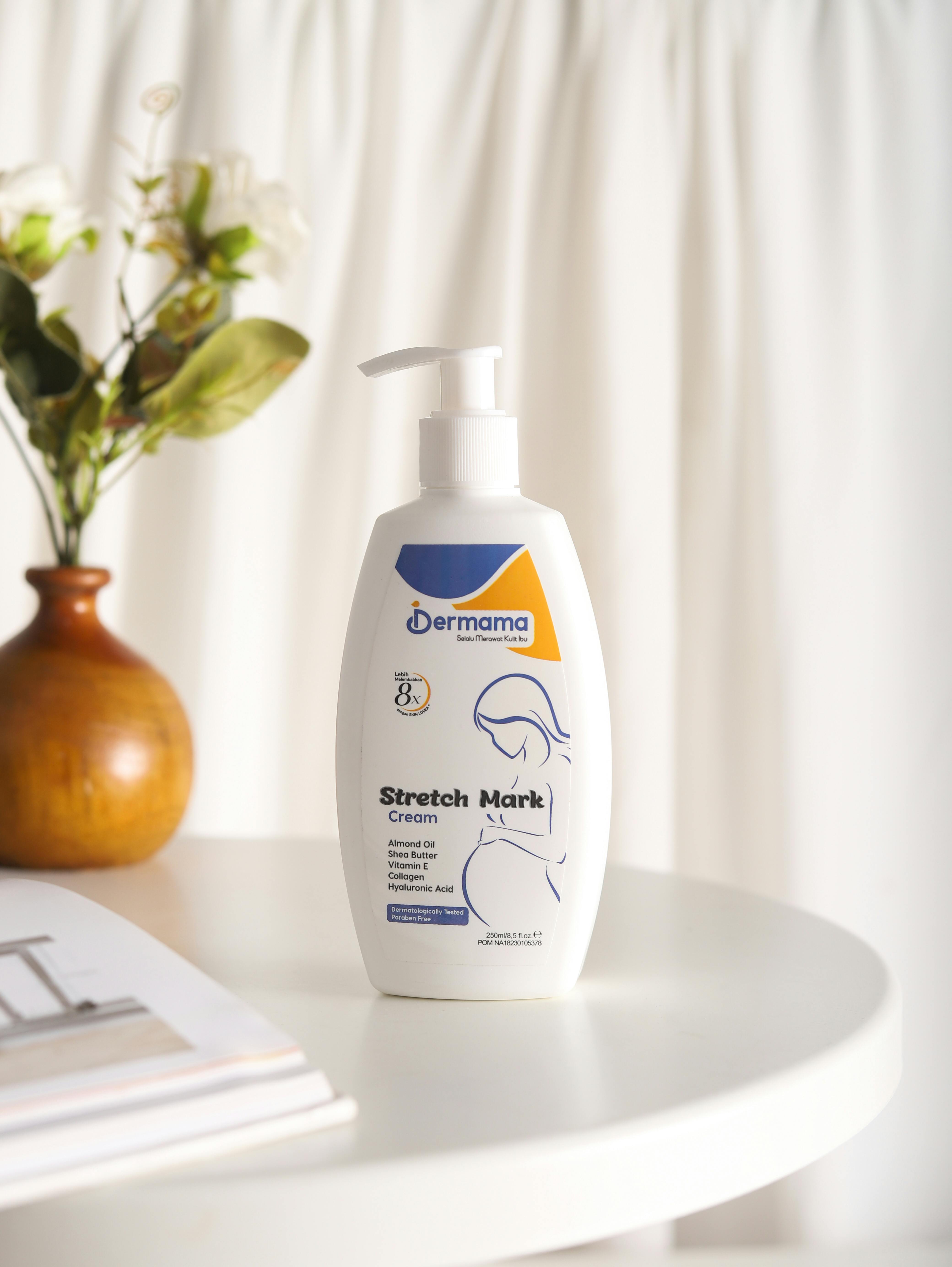 Skincare product dermama in bottle on white table · Free Stock Photo