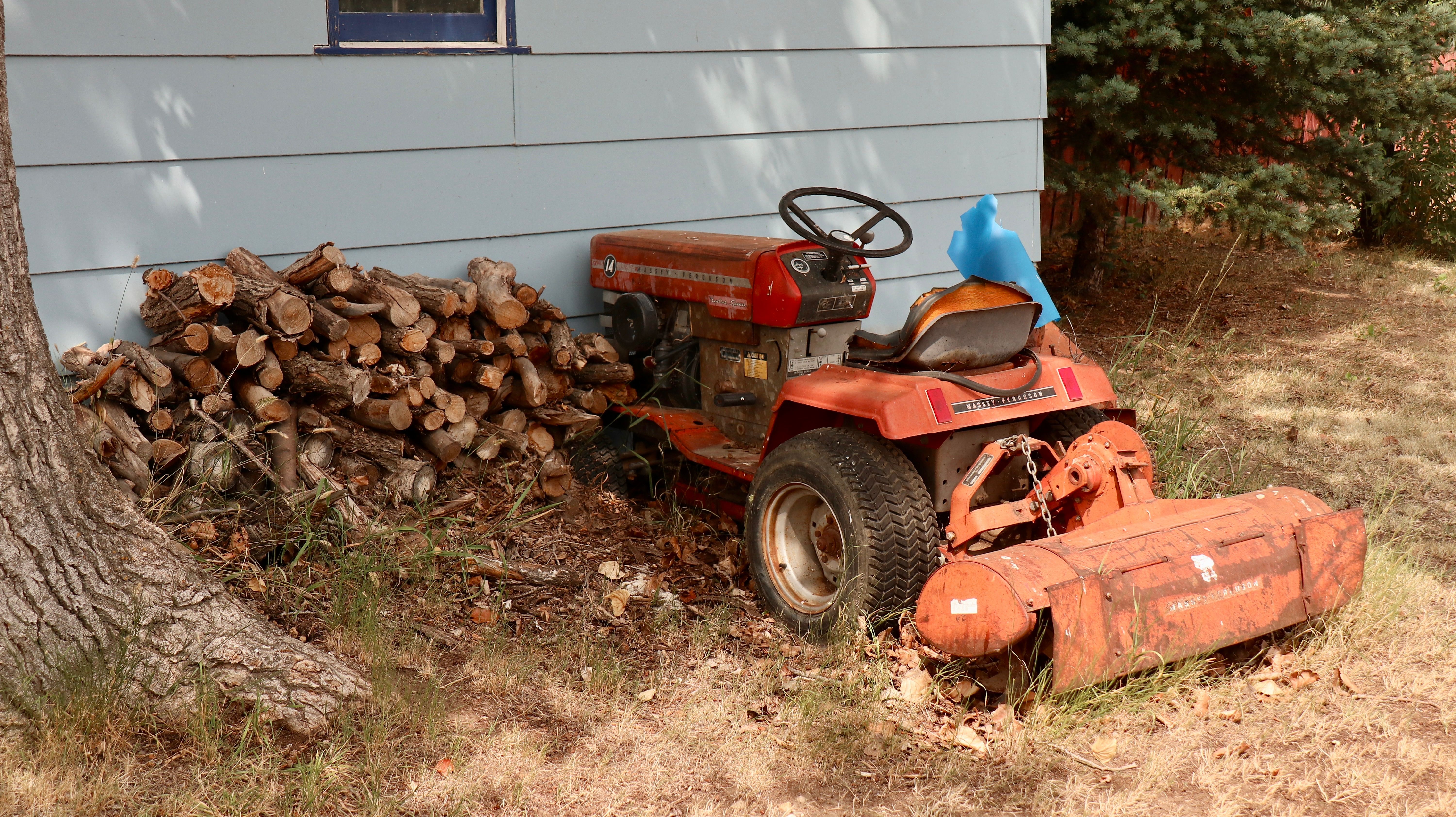 A tractor is parked in front of a house · Free Stock Photo