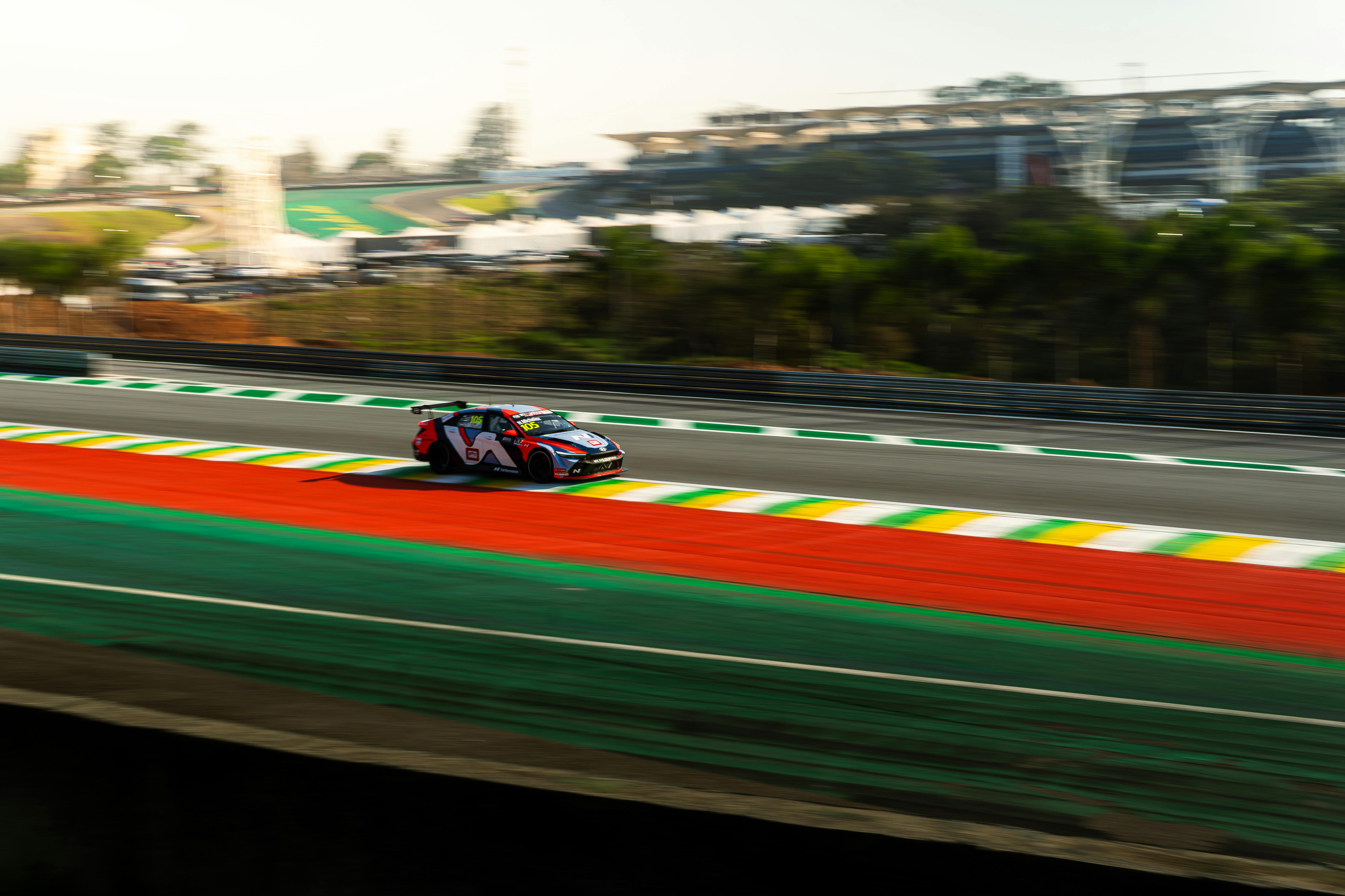 Red Racing Car on Race Track during Daytime · Free Stock Photo