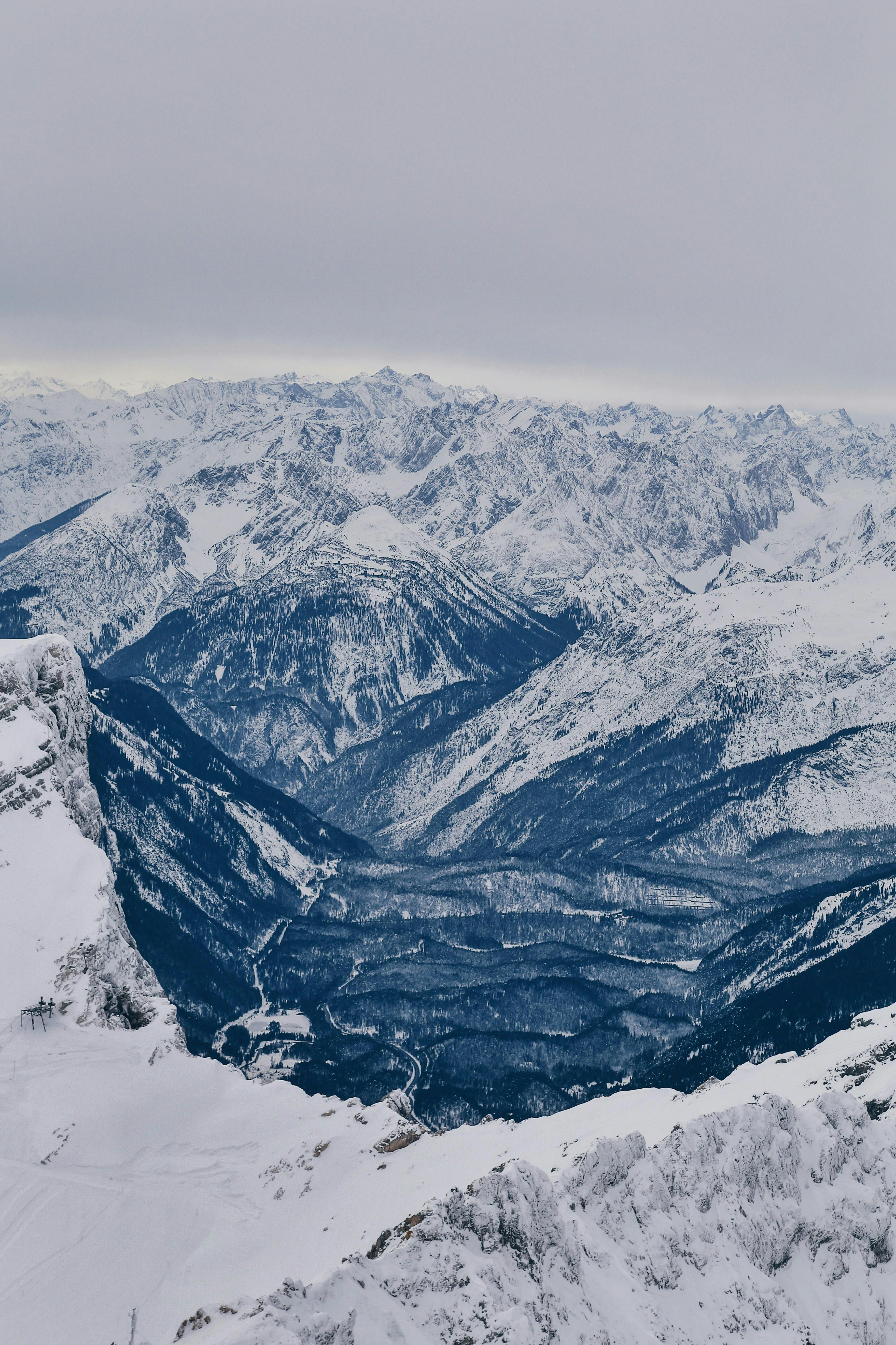 Scenic View of Snow Mountains Against Blue Sky · Free Stock Photo