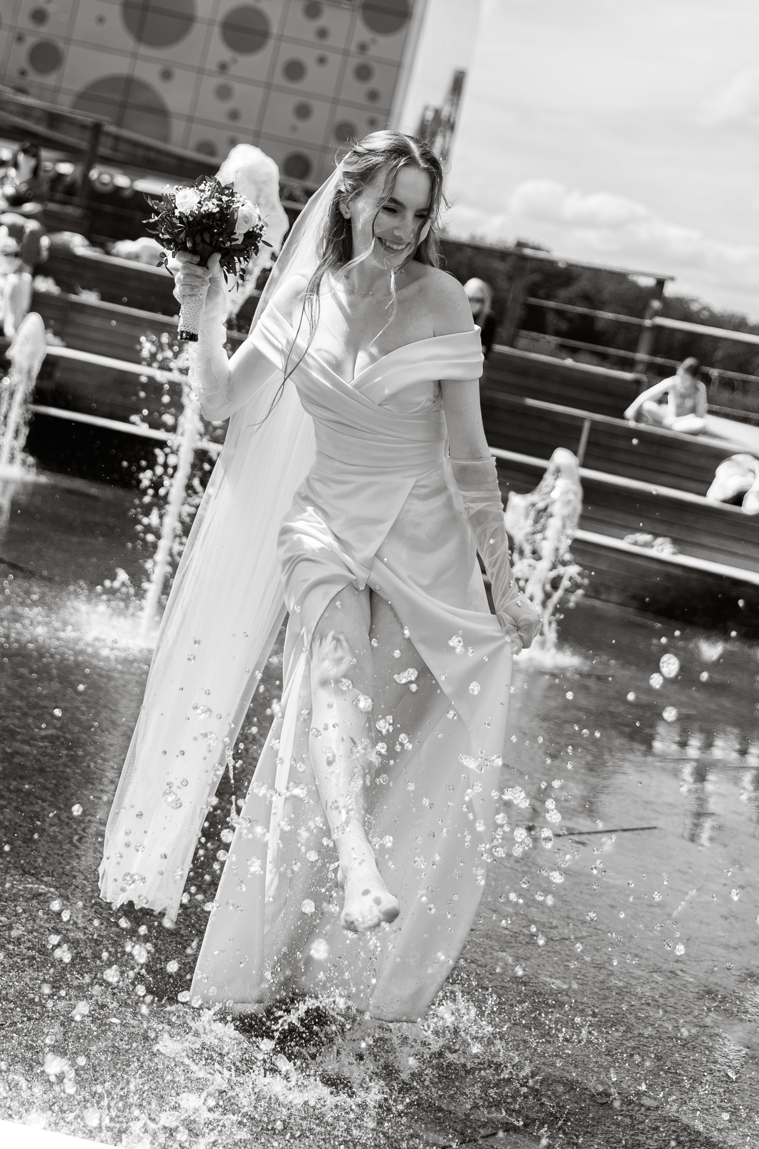 A bride in a wedding dress splashing water · Free Stock Photo