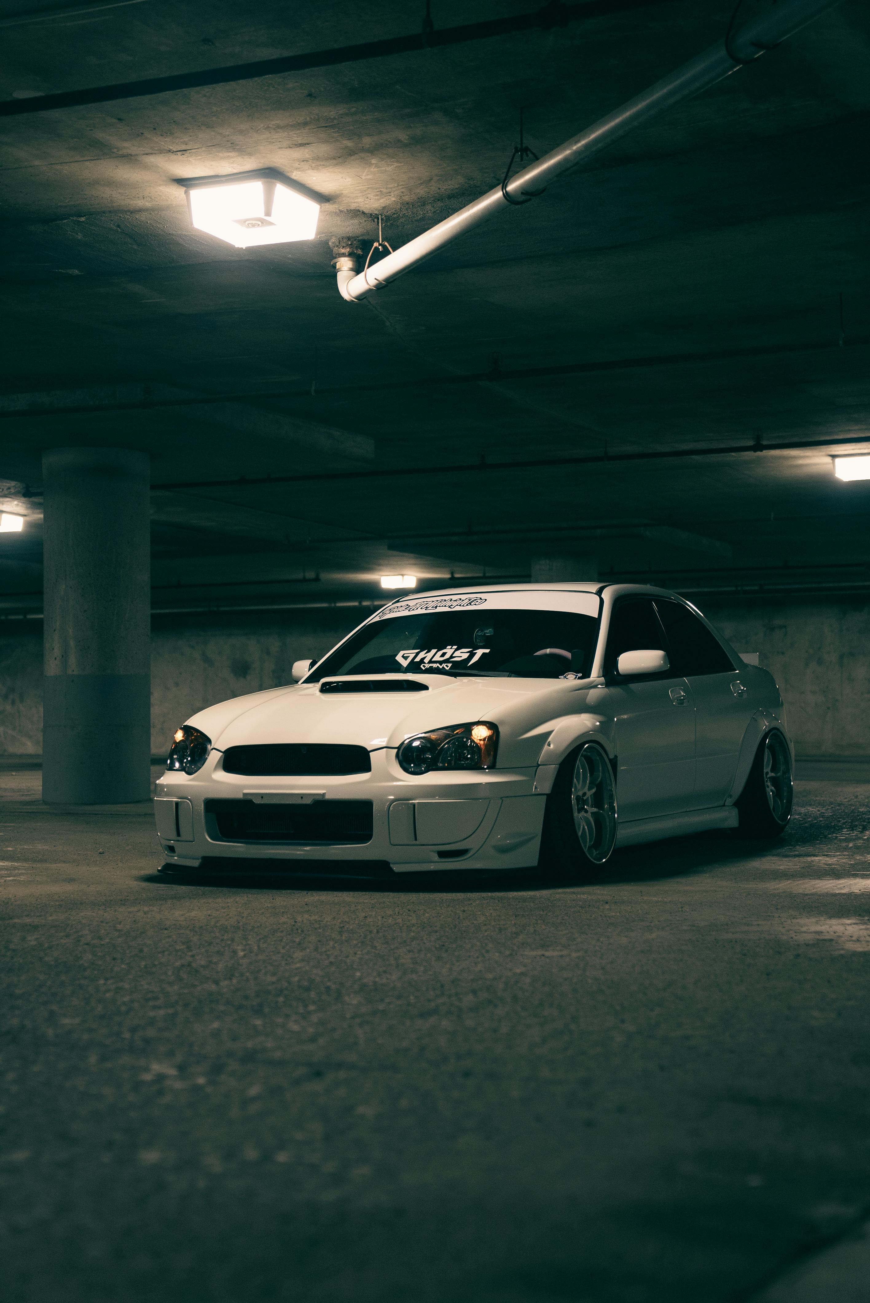 Photo Of White Sedan Parked · Free Stock Photo