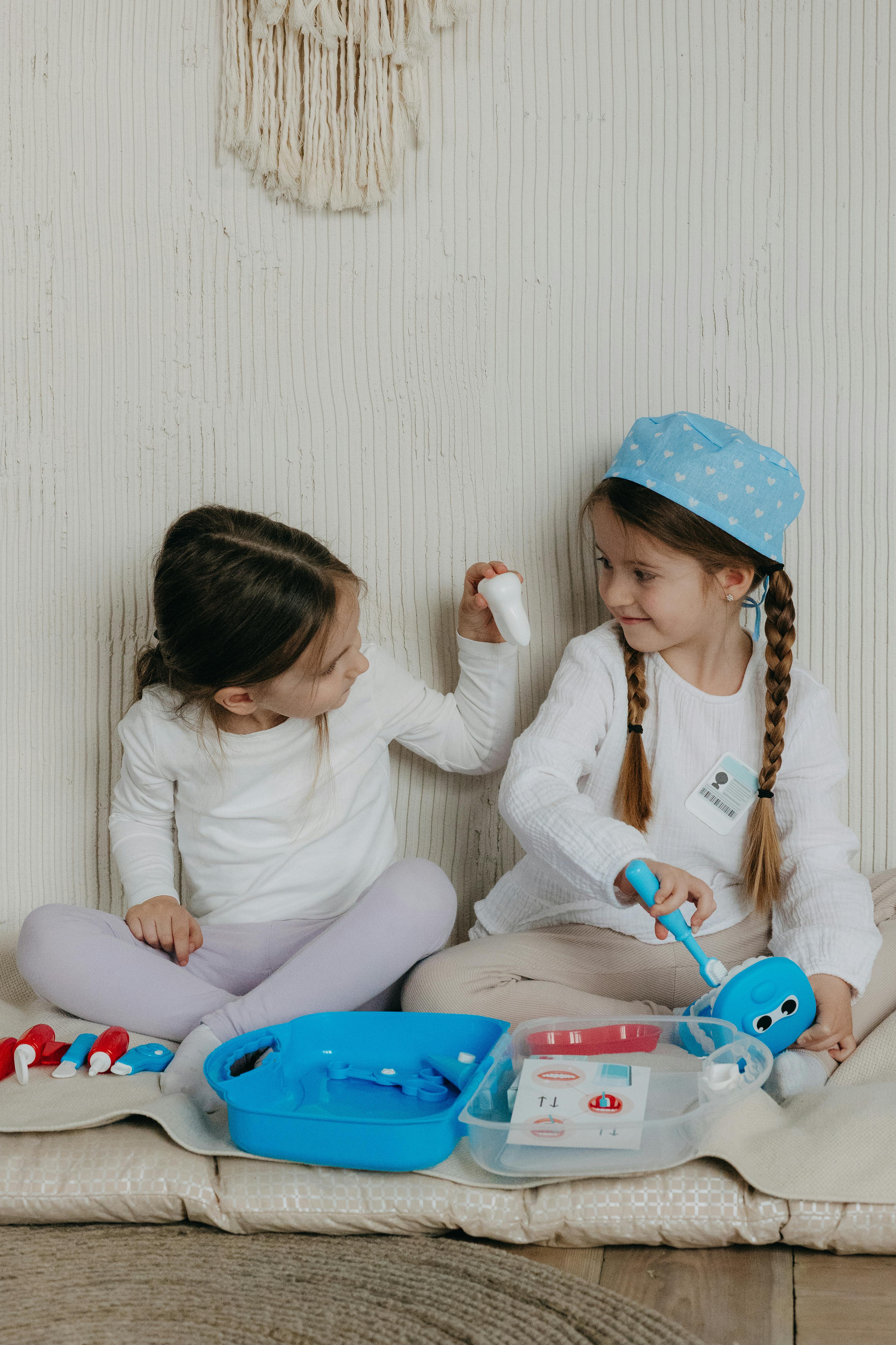 Two little girls playing with a toy boat · Free Stock Photo