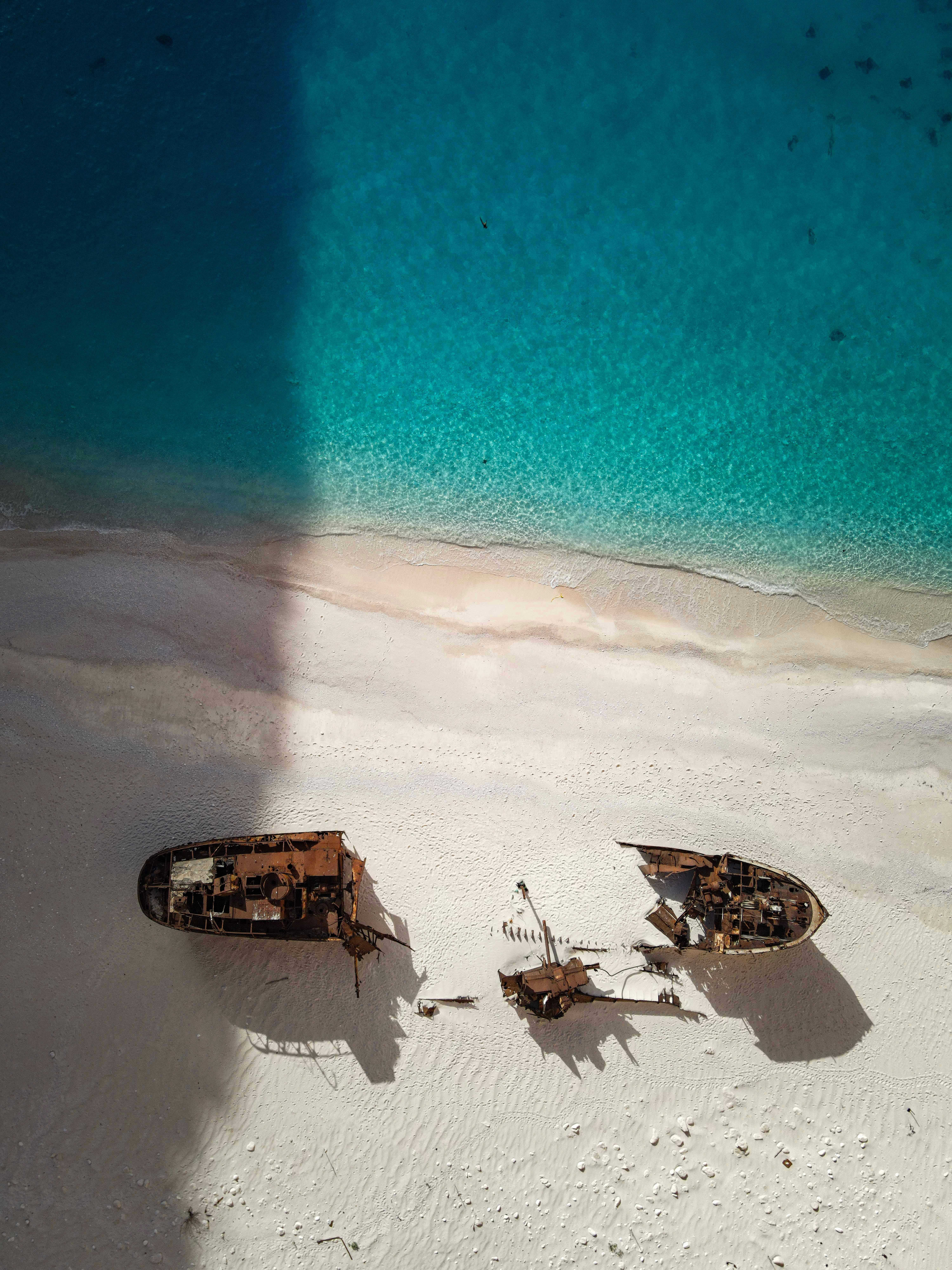 Aerial View of Shipwreck on Beach by Sea · Free Stock Photo